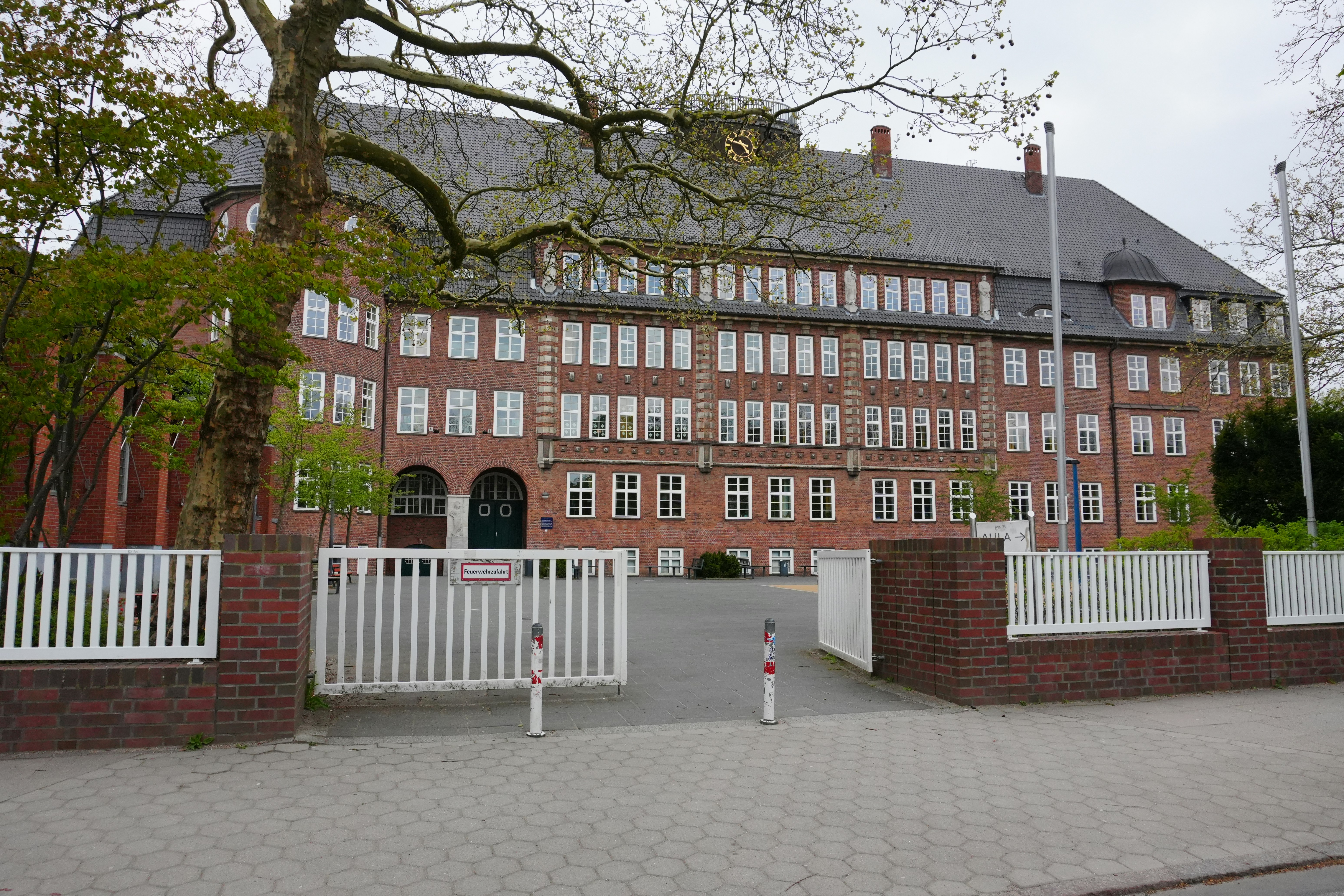 Brick Campus Entrance Framed by Gate and Trees