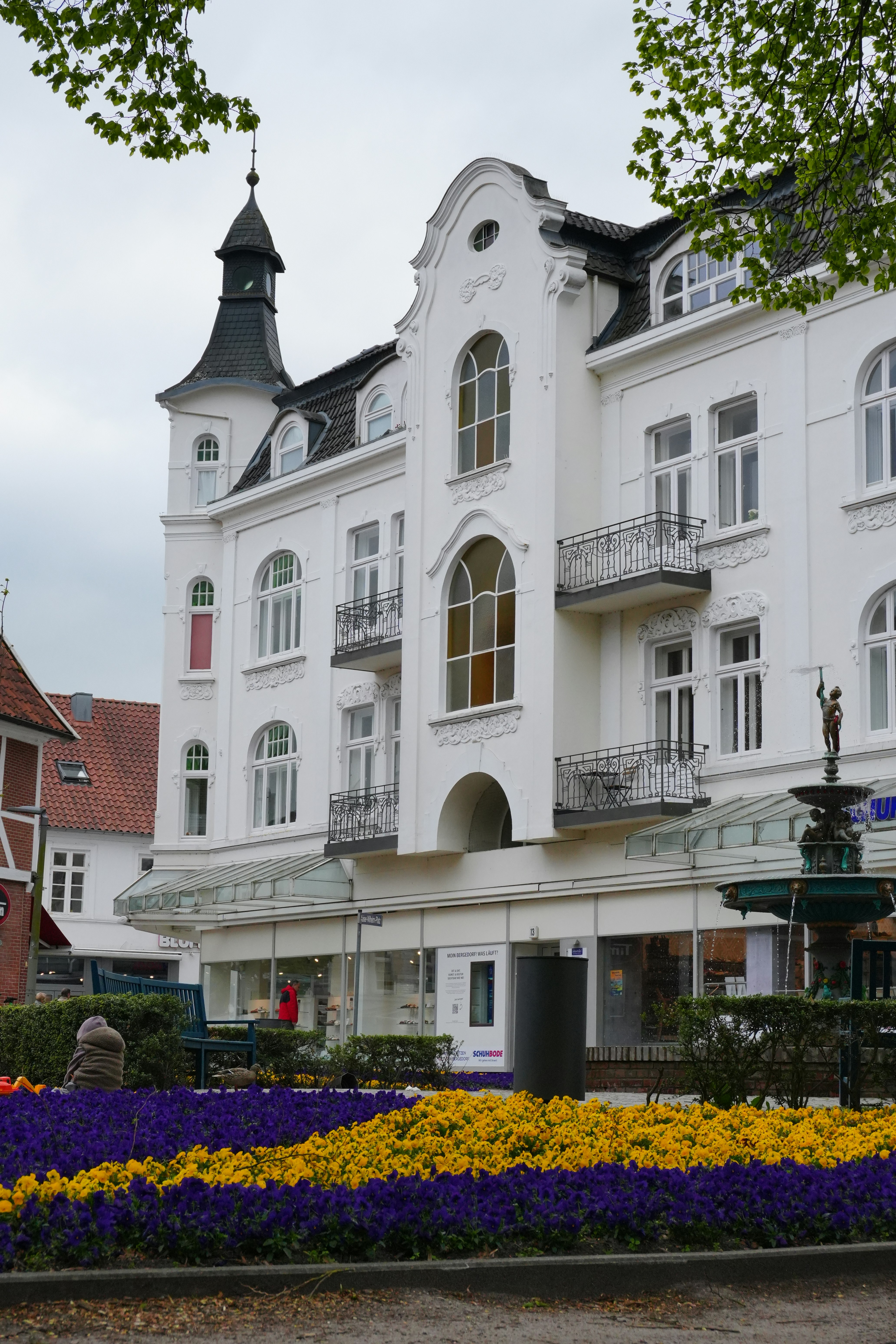 White Florentine-style Facade with Colorful Front Garden