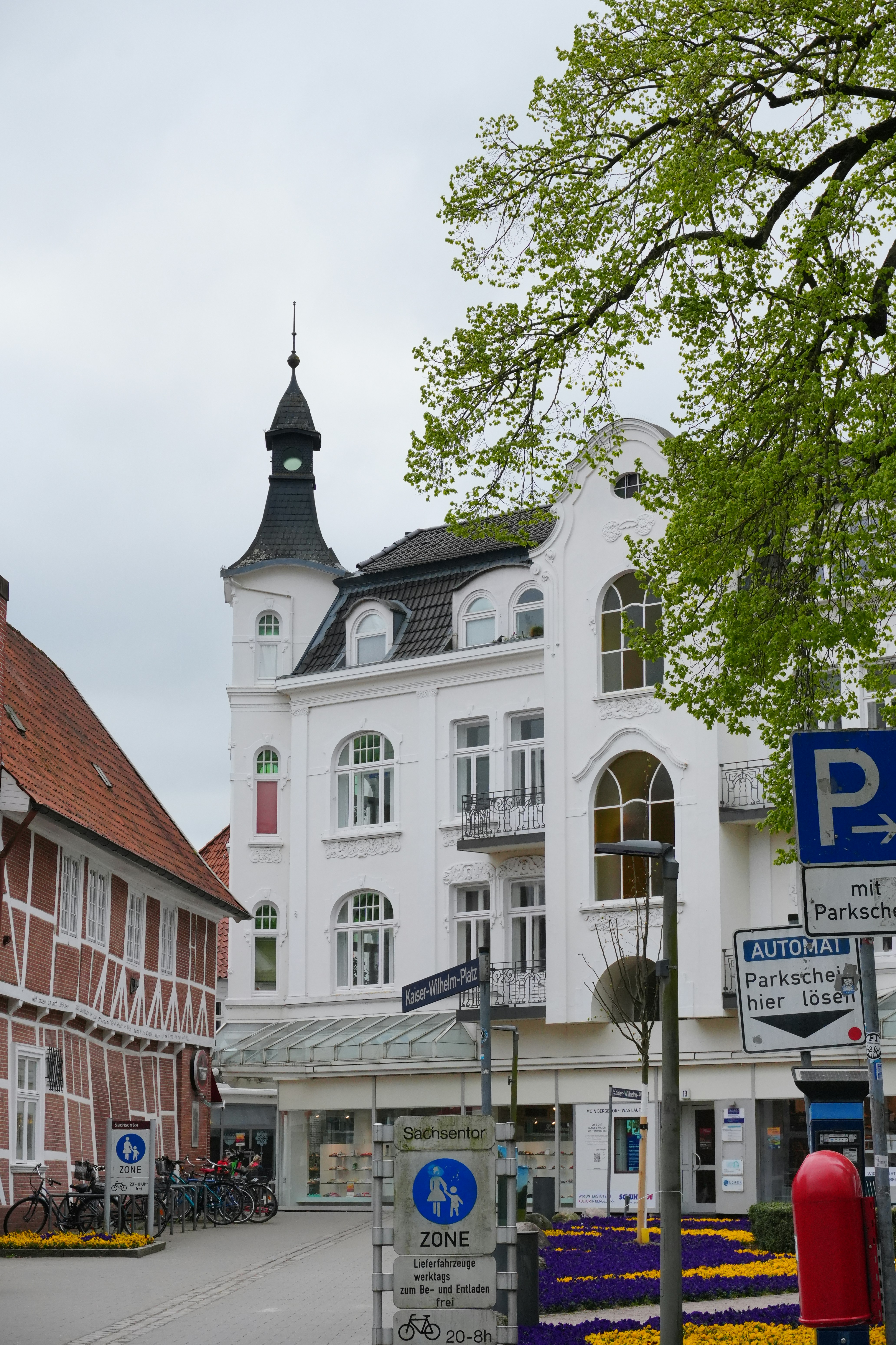 White Facade and Turreted Rooftops in a European Street