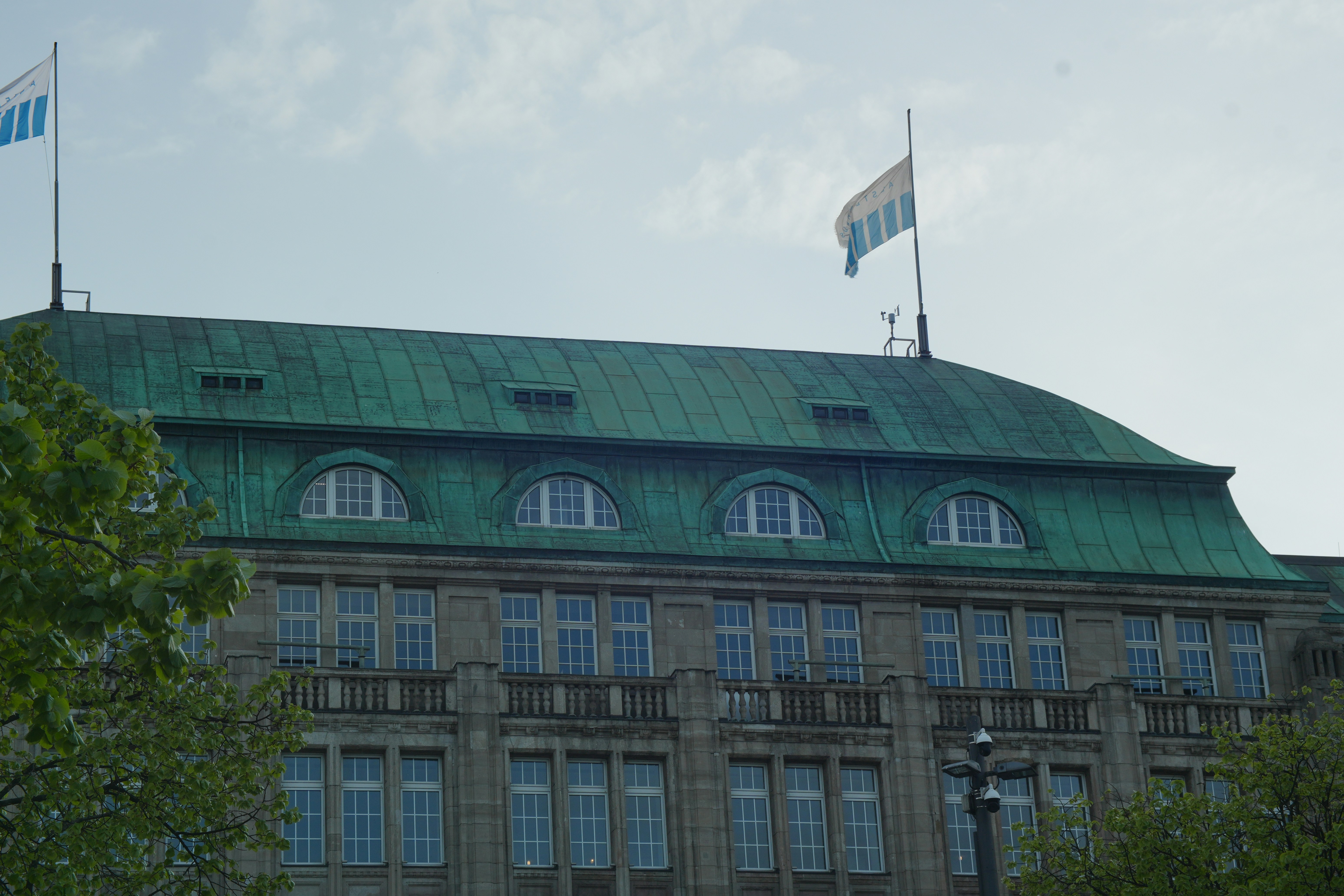 Green Roof, Stately Facade: A Historic Office Building Under Soft Skies