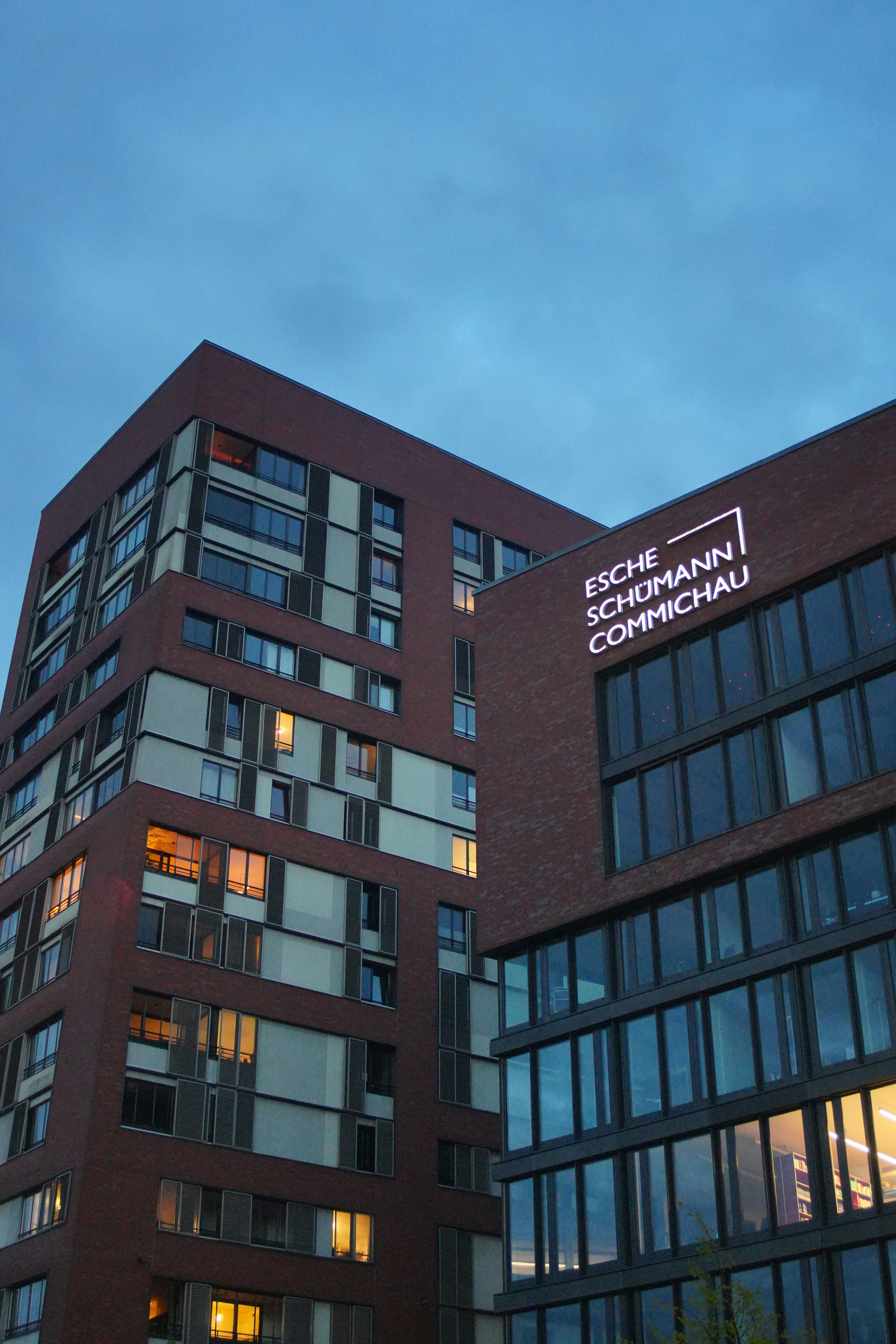 Brick Facade and Neon Sign: A Modern City Office