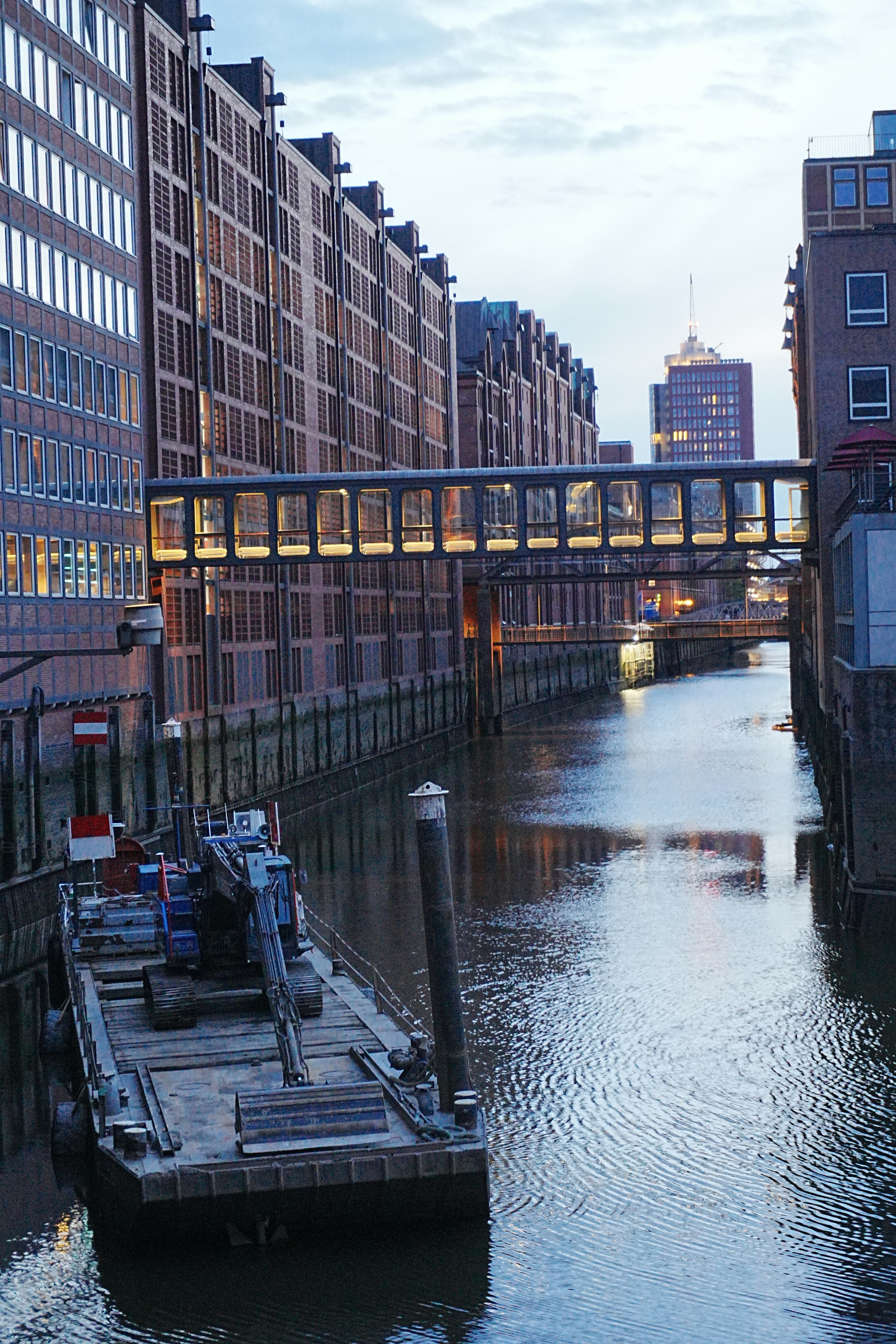 Bridge over the canal: morning light through a glass walkway