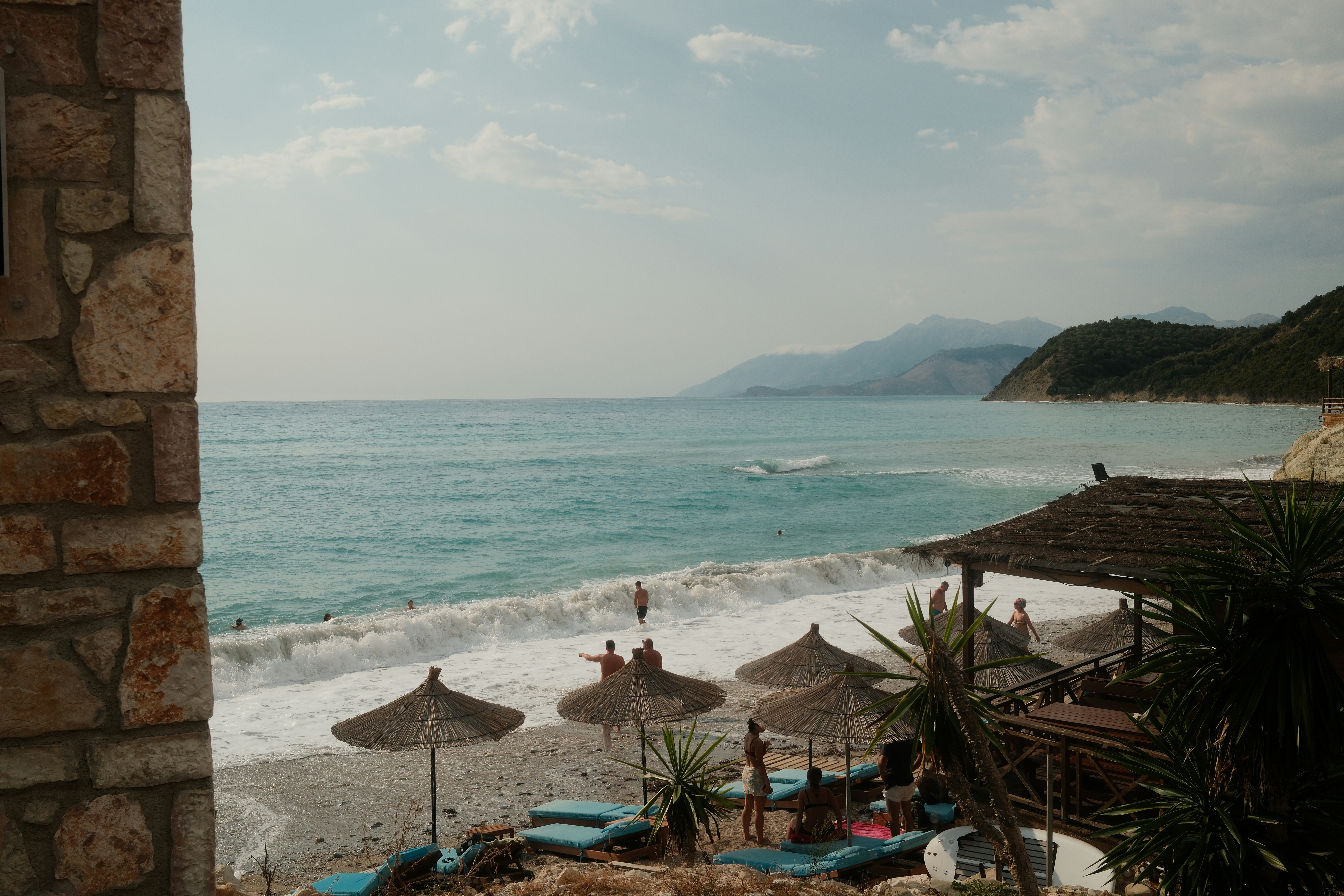 Sea Breeze and Straw Umbrellas: A Beachfront Moment in Dusk Light
