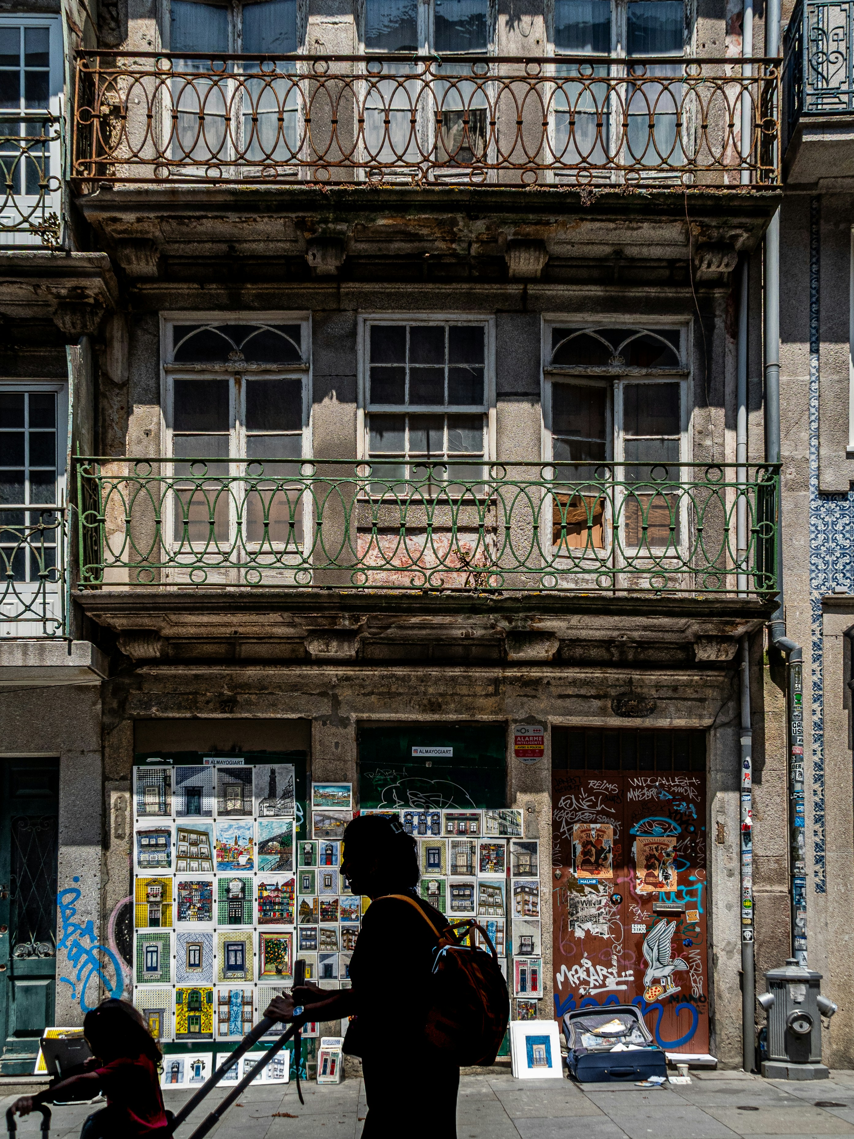 Balcony Echoes: Street-level Portraits Beneath Weathered Facades