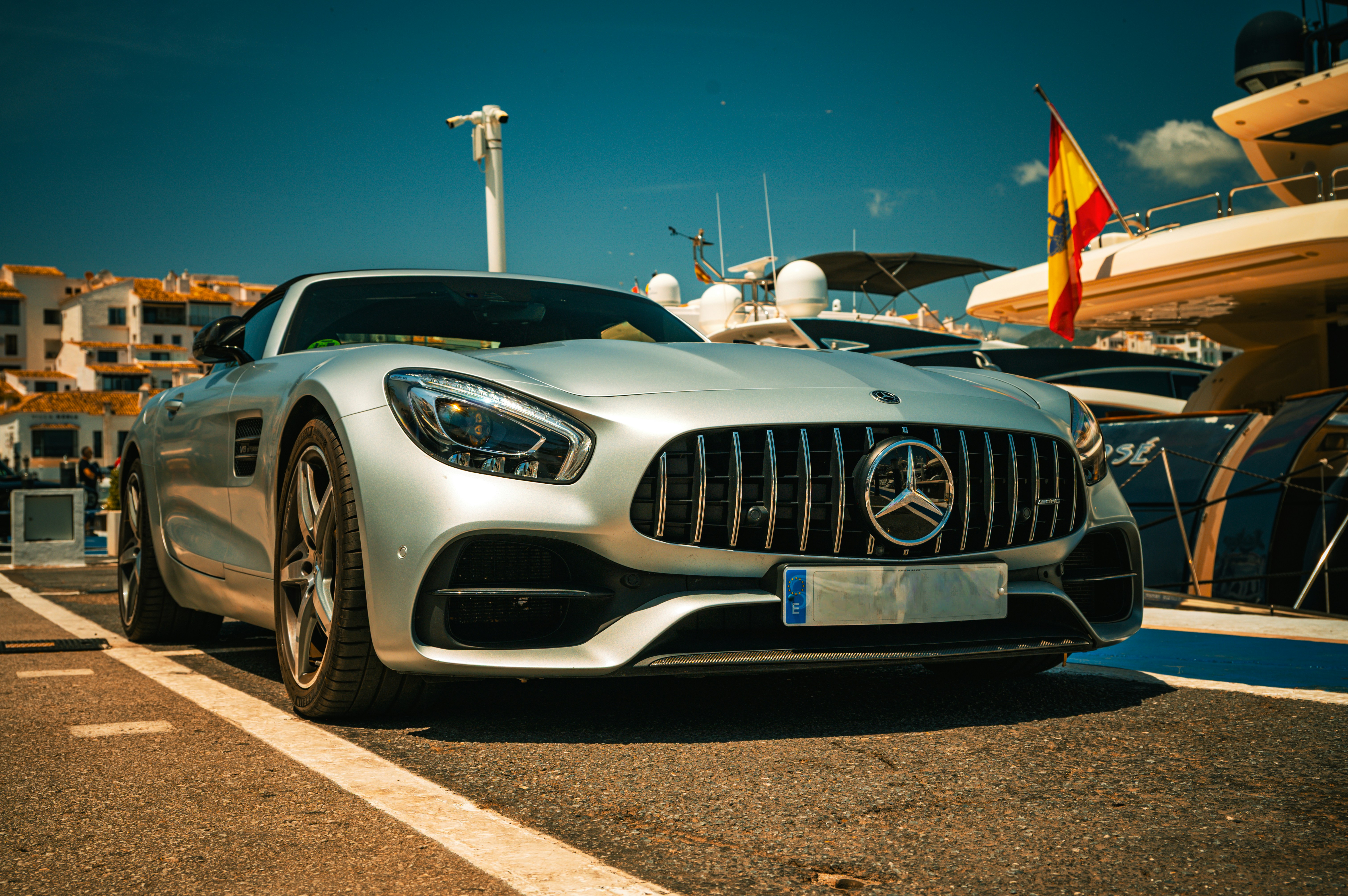Silver Stallion at the Marina: A Mercedes AMG Gleams Under Blue Sky
