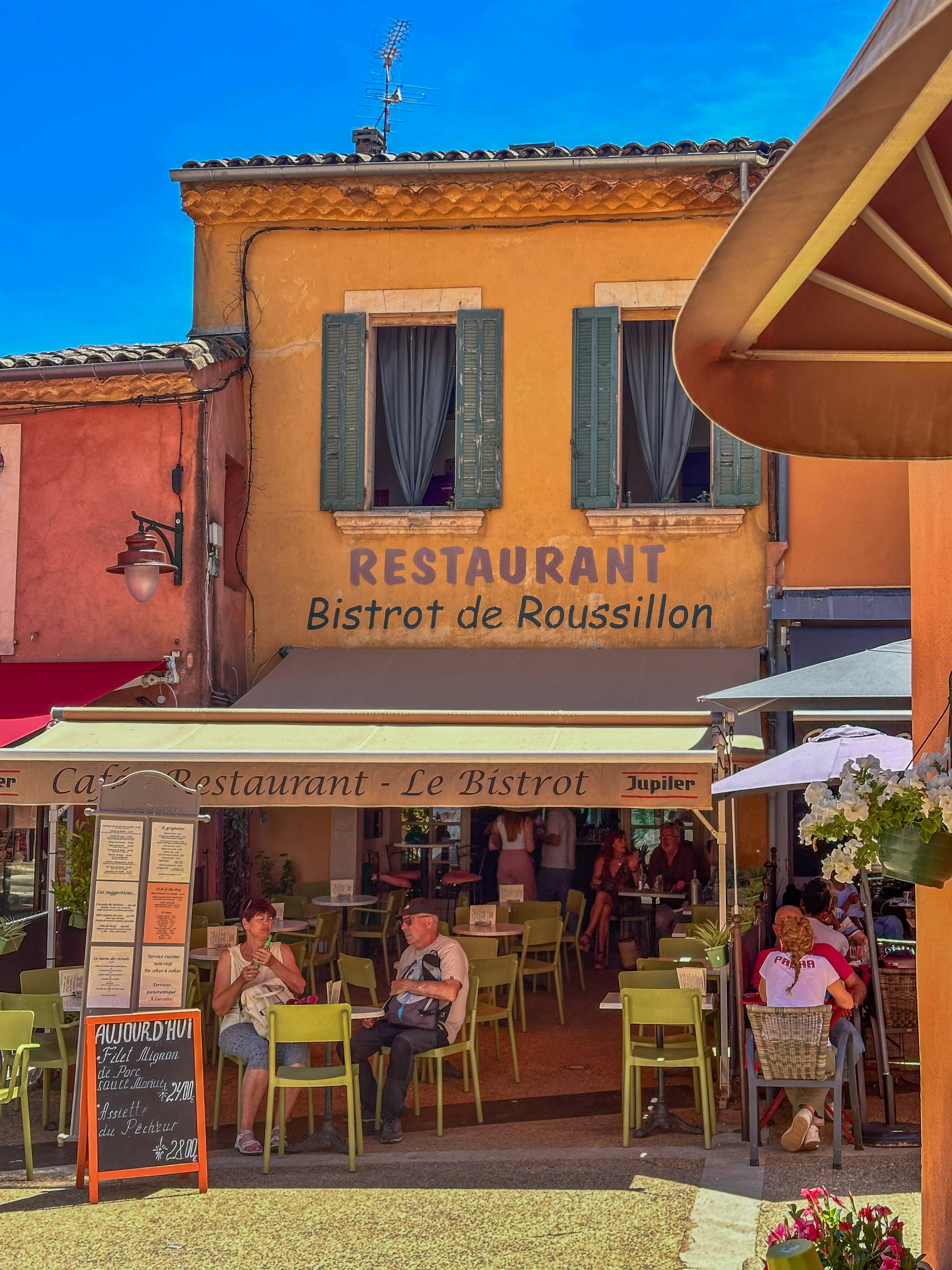 Café Terrace Under a Sunlit Mediterranean Facade