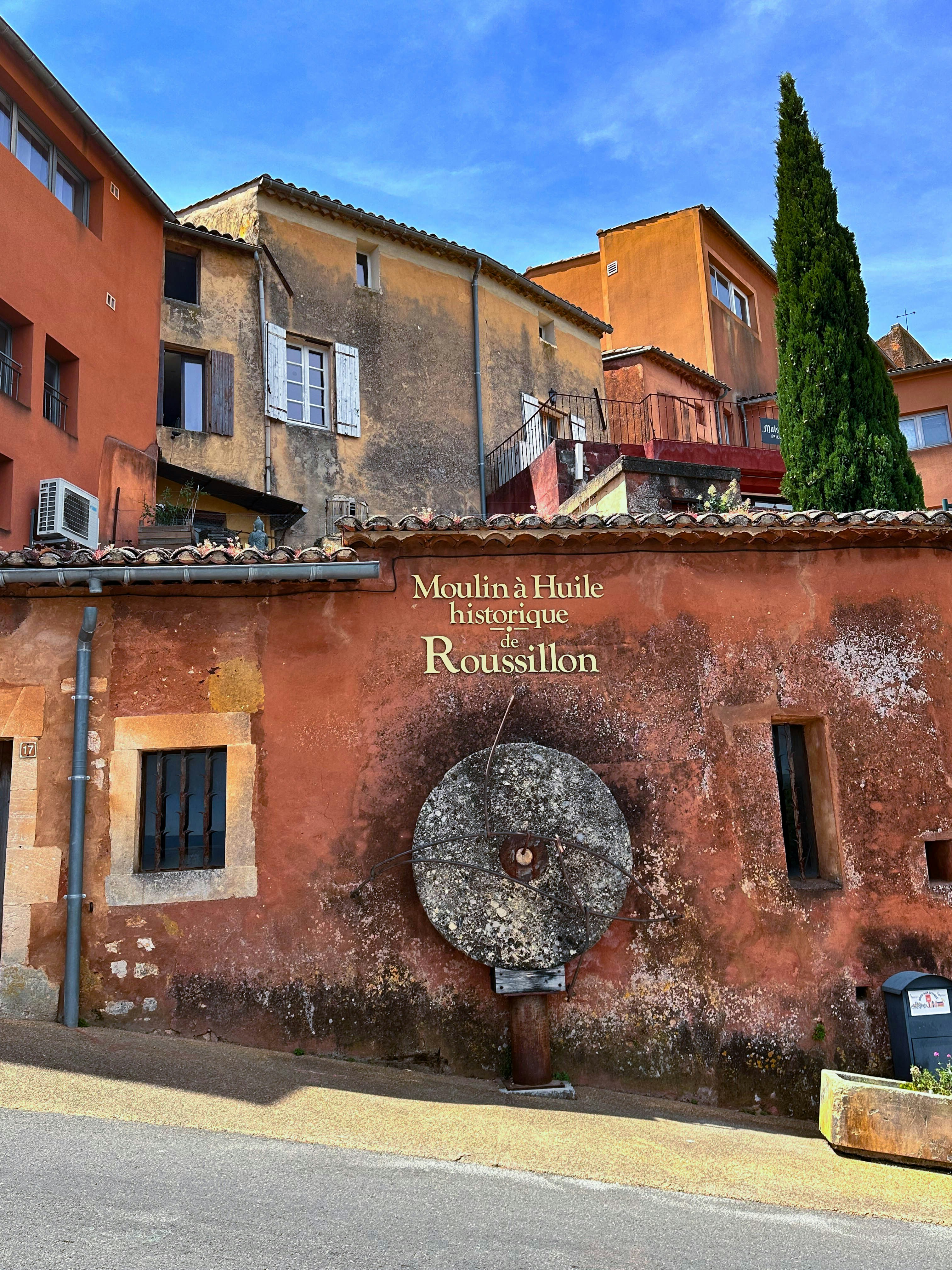 Old Mill Stone and Sunlit Facade of Roussillon