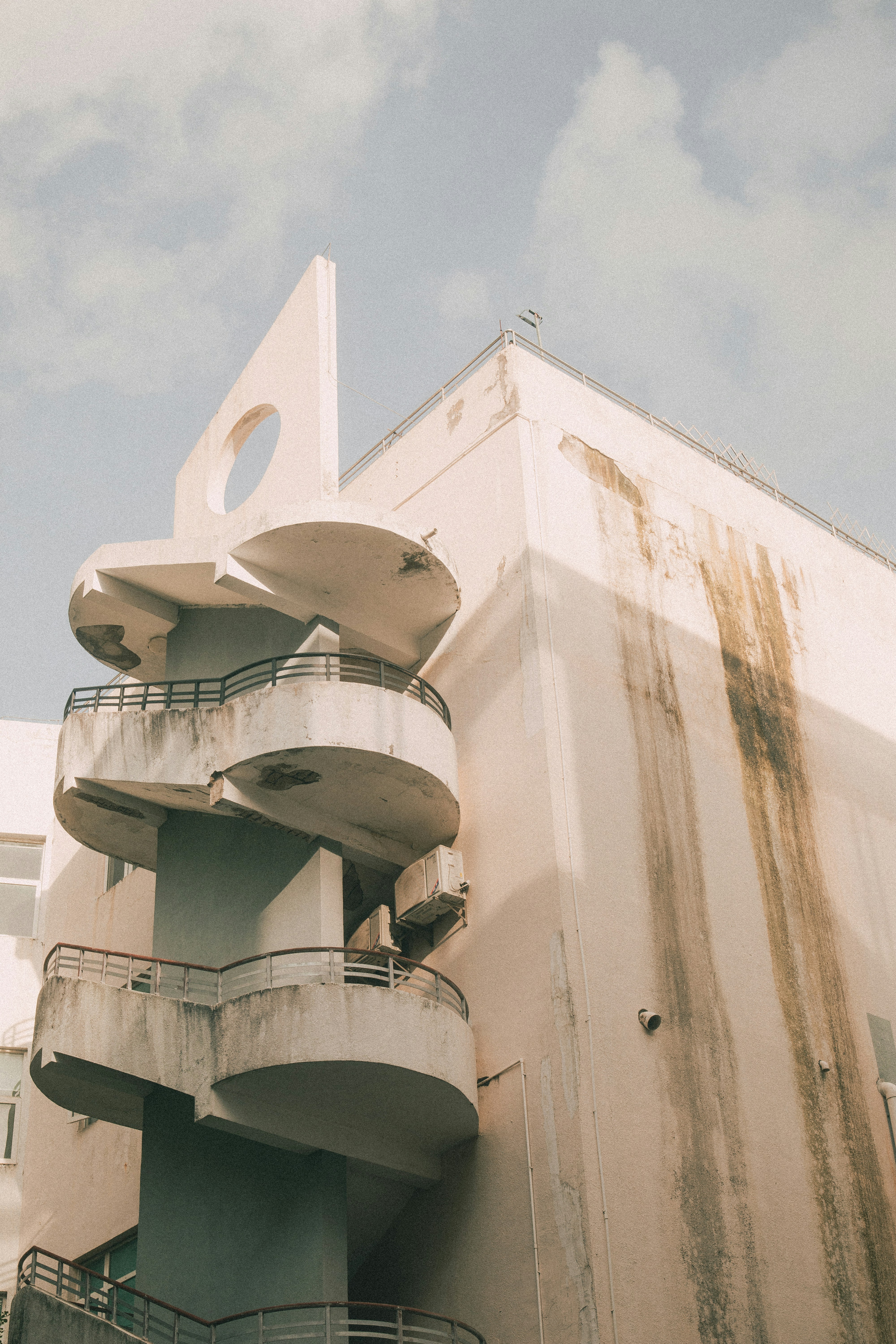 Concrete Spiral: A Weathered Facade Reaches Toward the Sky