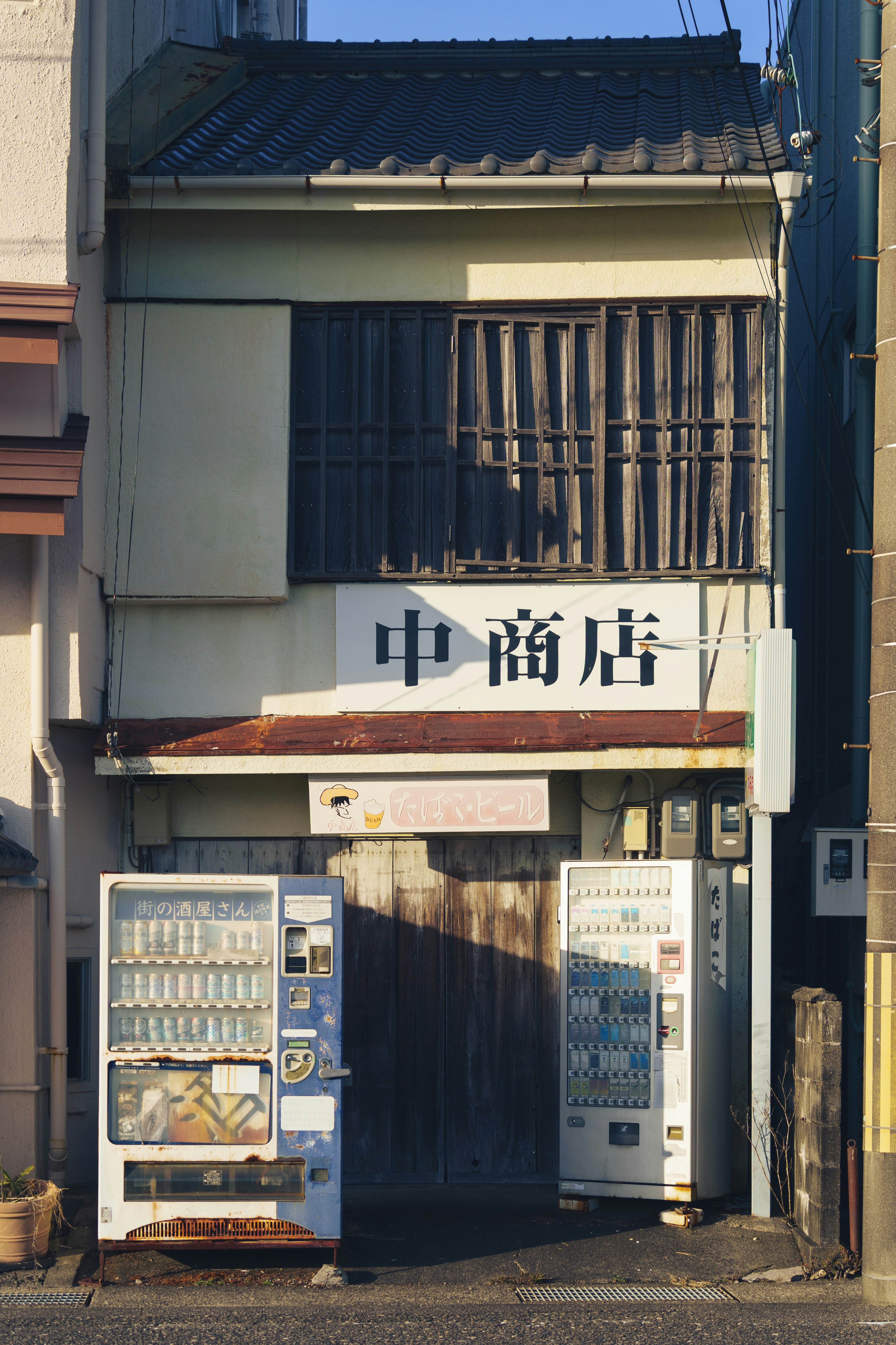 Shuttered Japanese storefront under a tiled roof