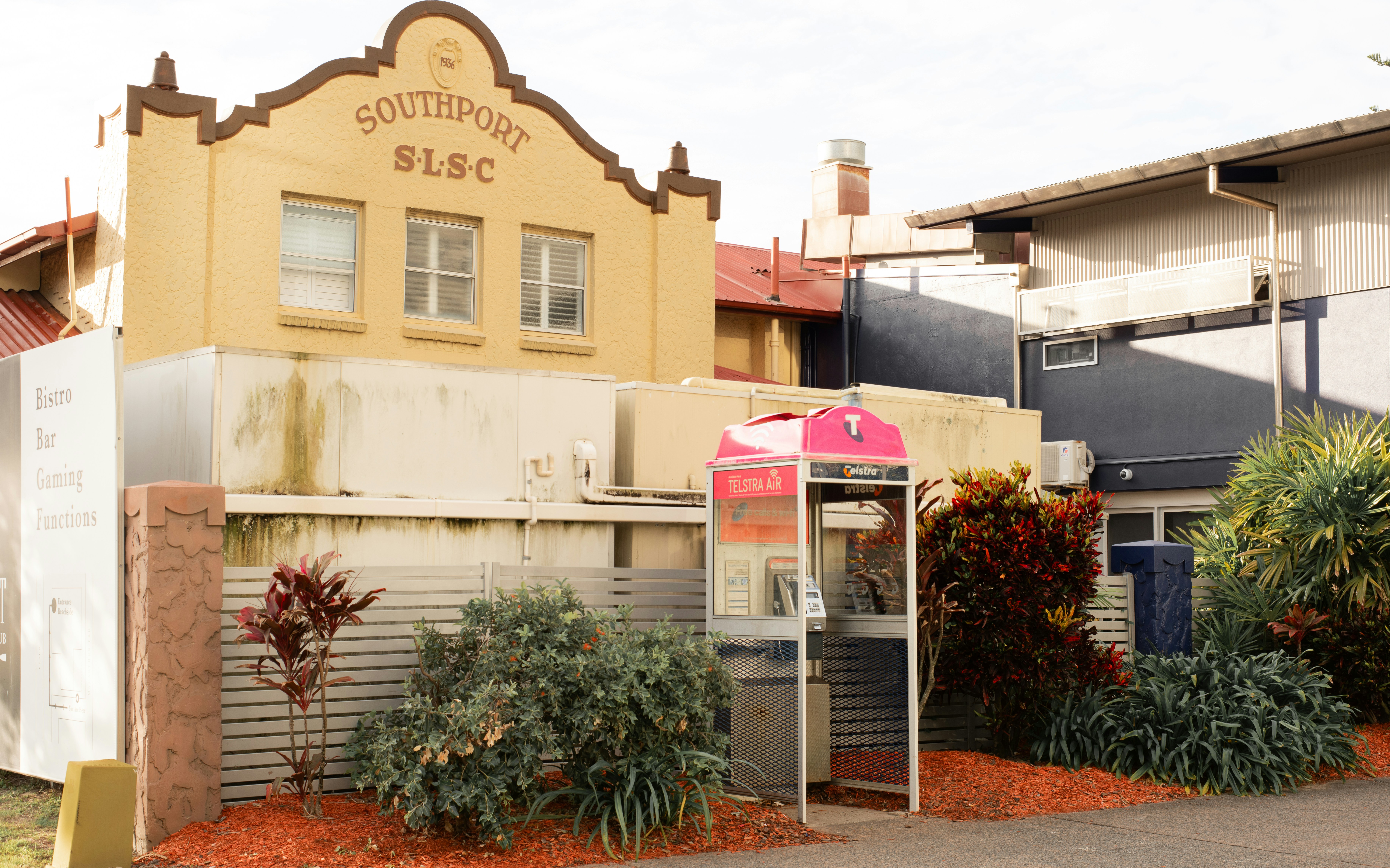 Southport Sideshow: A Retro Street Scene Framed by a Bright Red Kiosk