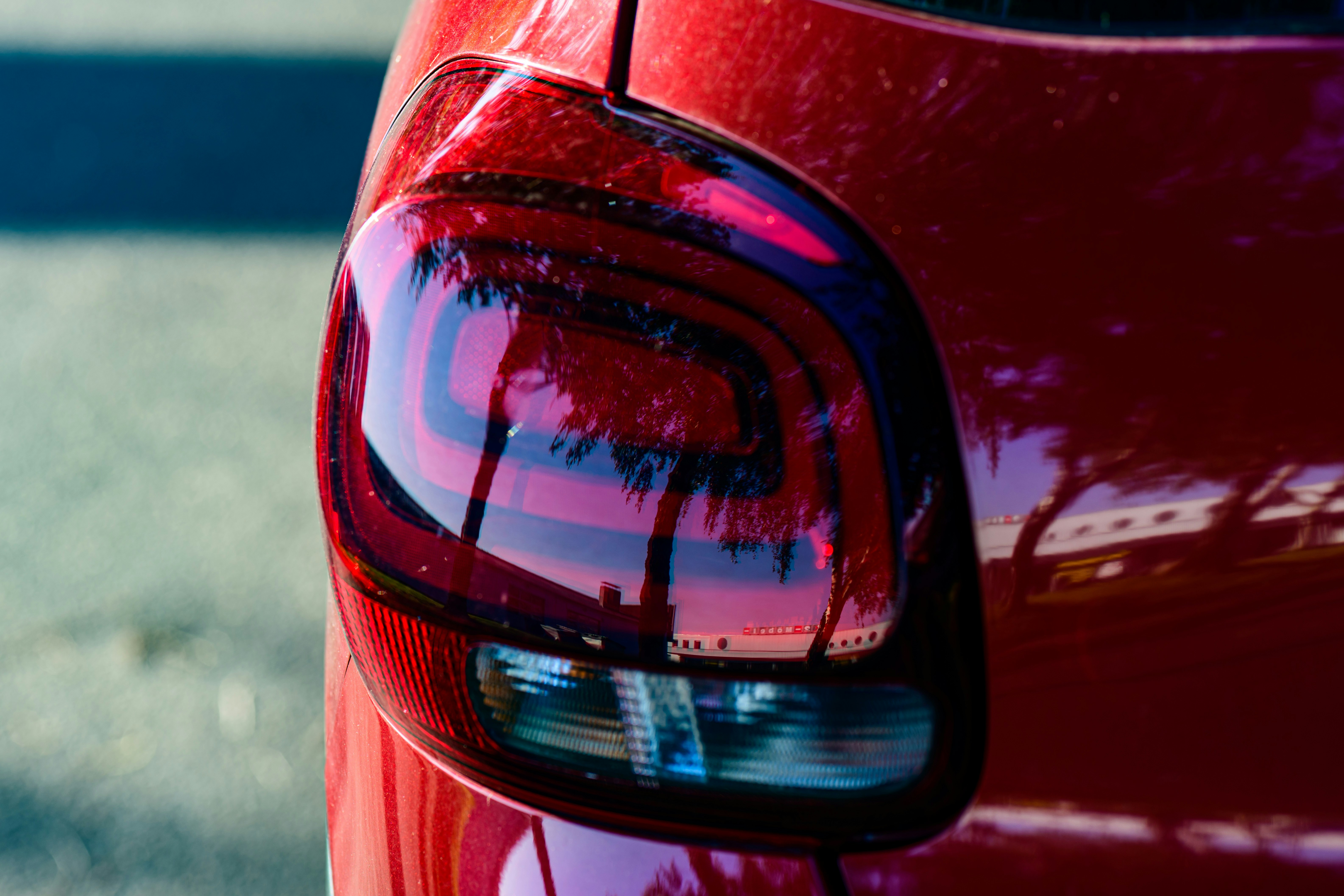 Red Tail Light Echo: Reflections and Gloss Under Sunlit Curves