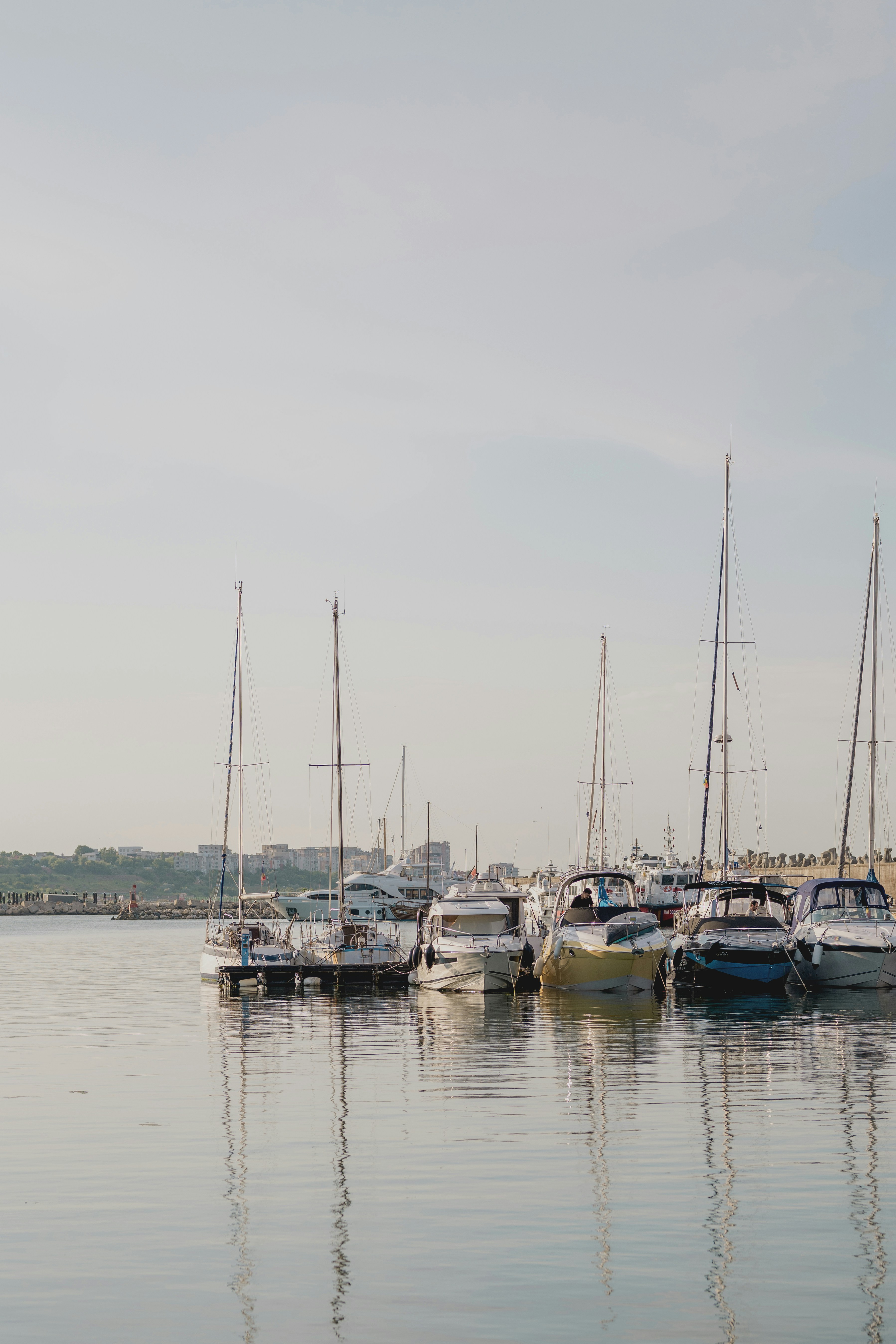 Quiet Marina: Rows of Docks and Sailed Sails Reflecting at Dusk