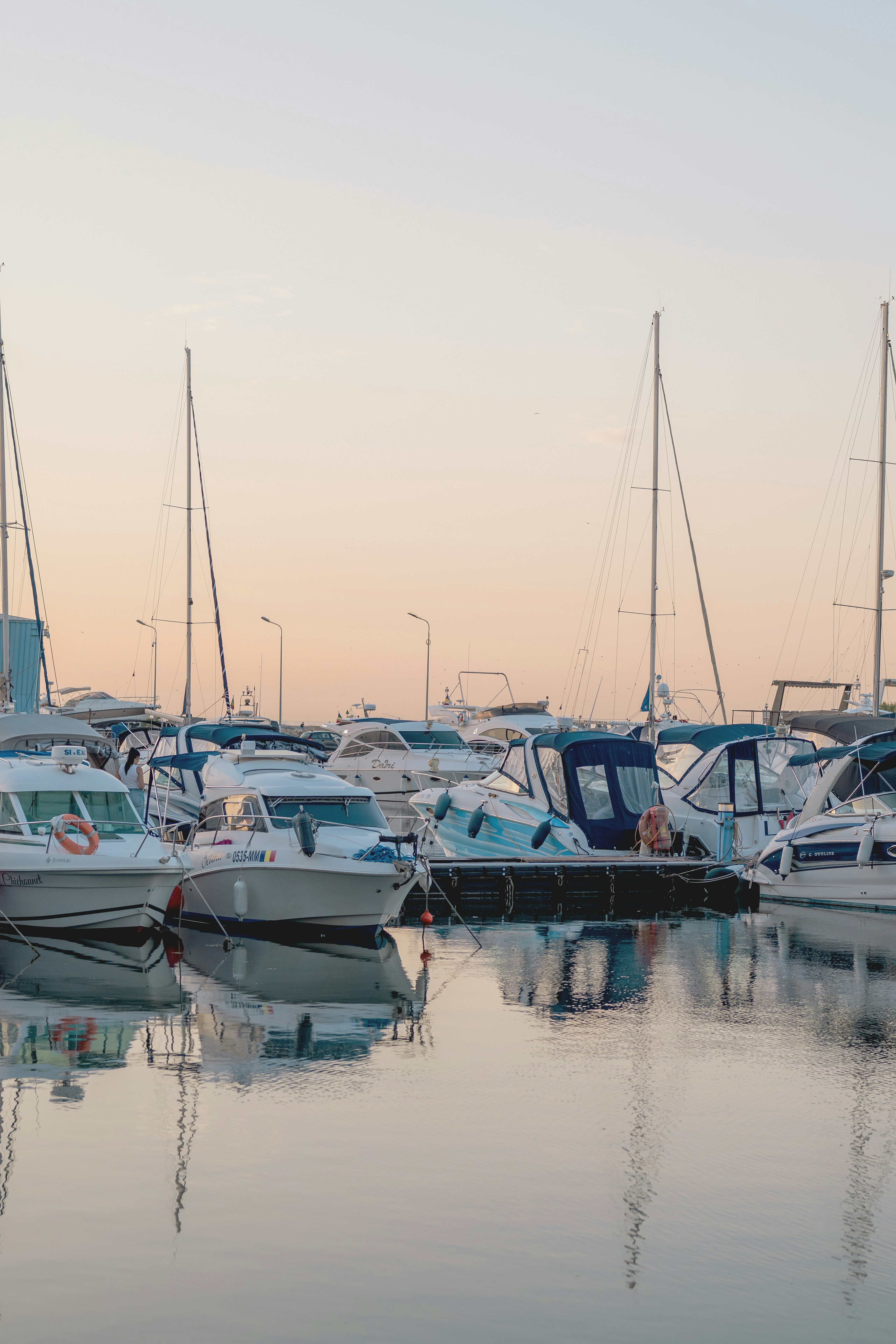 Harbor Echoes at Dusk: Boats Rest on Mirror-like Water
