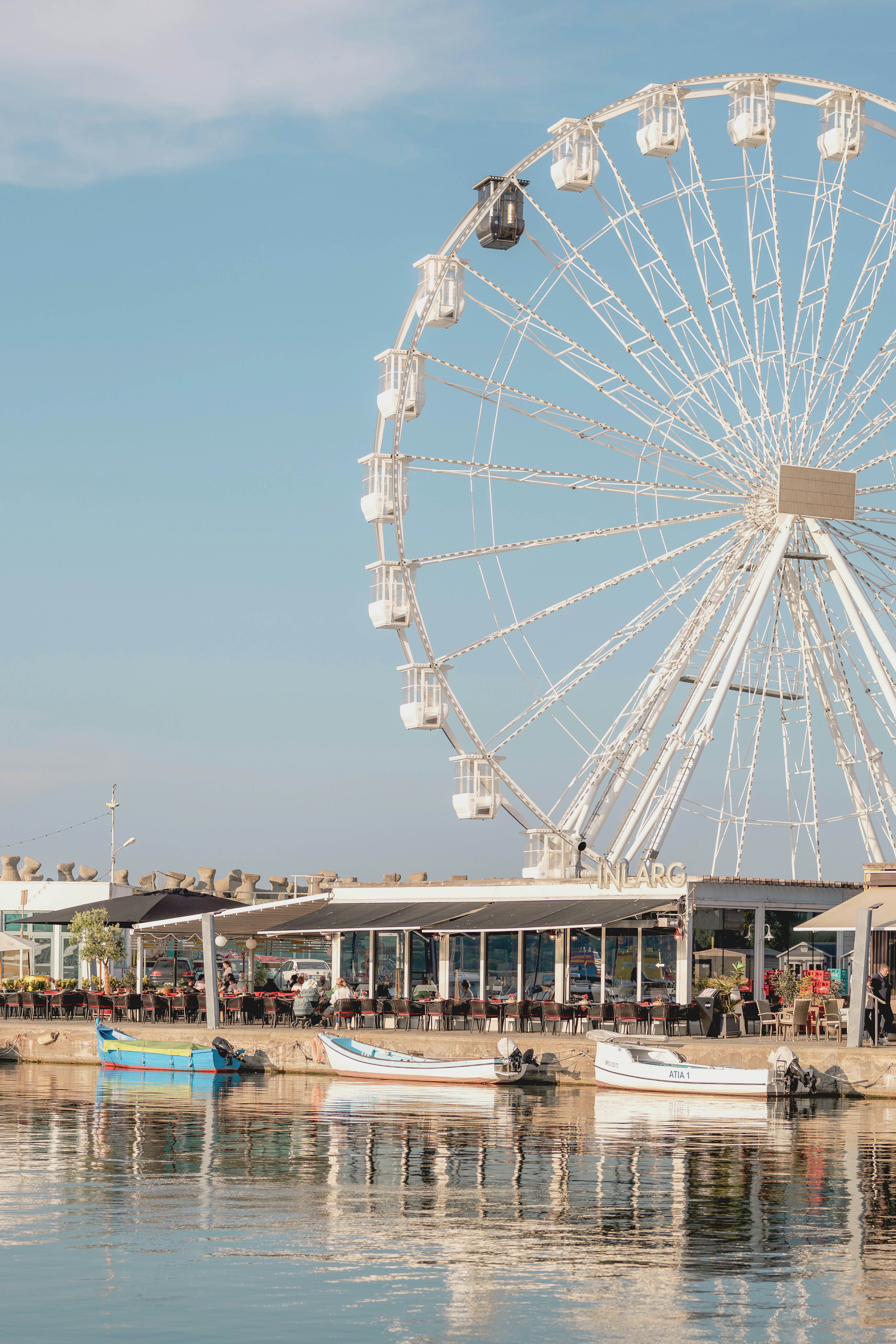 Giant Wheel by the Waterfront: Light, Boats, and Gentle Ripples