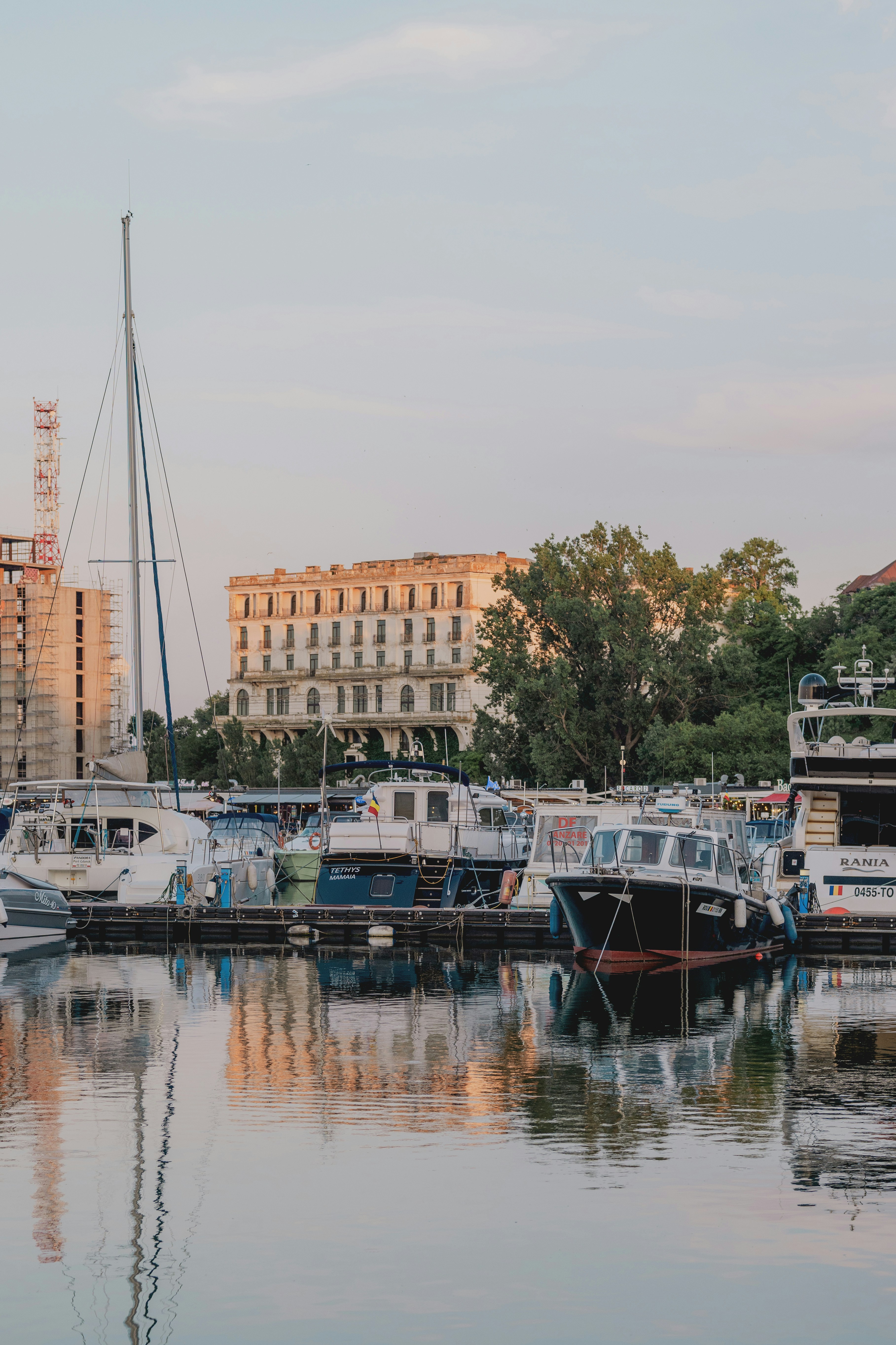 Harbor Reflections: Boats and a Historic Facade in Soft Evening Light