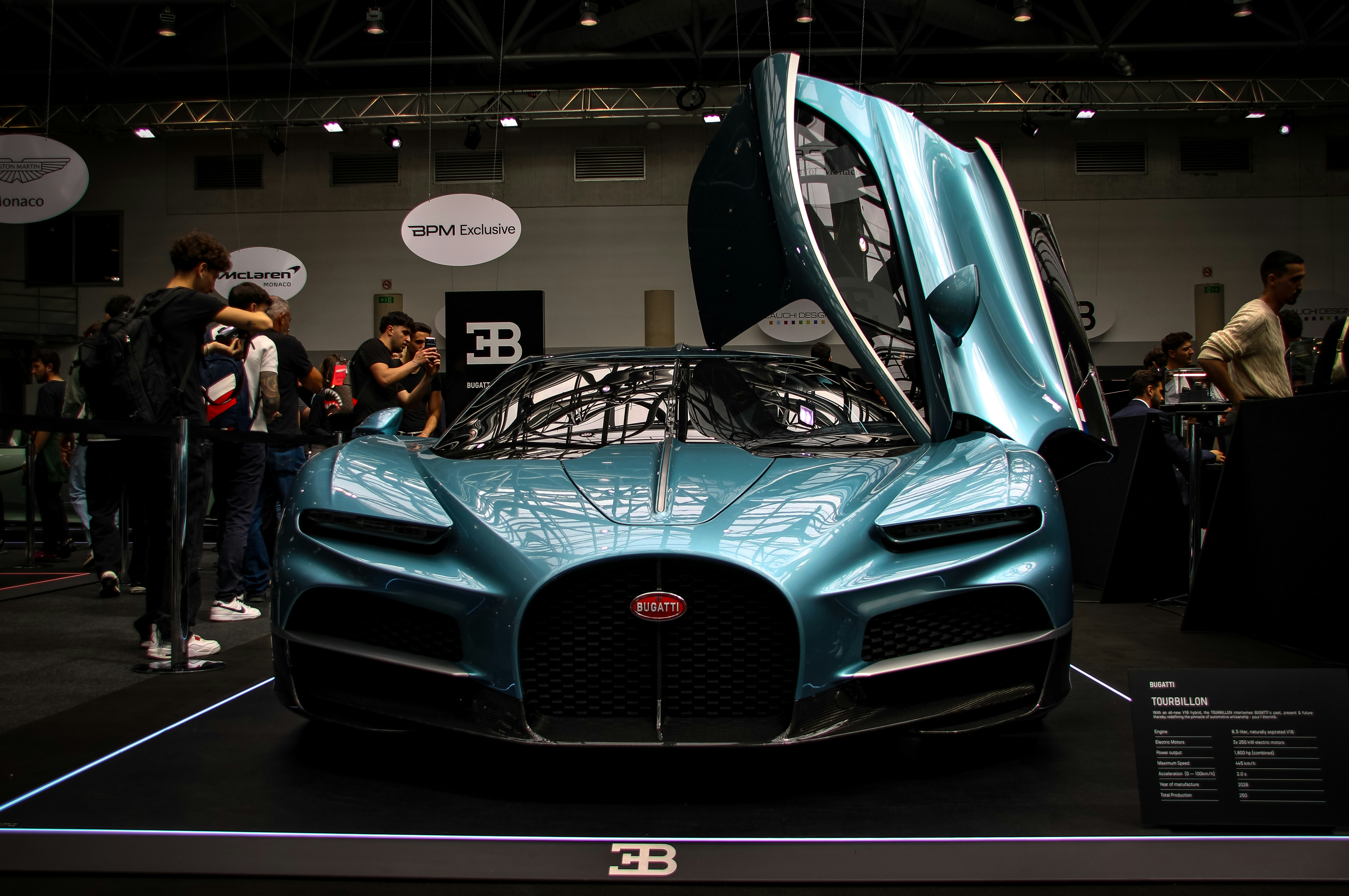 Open-Hood Power: A metallic blue Bugatti on display
