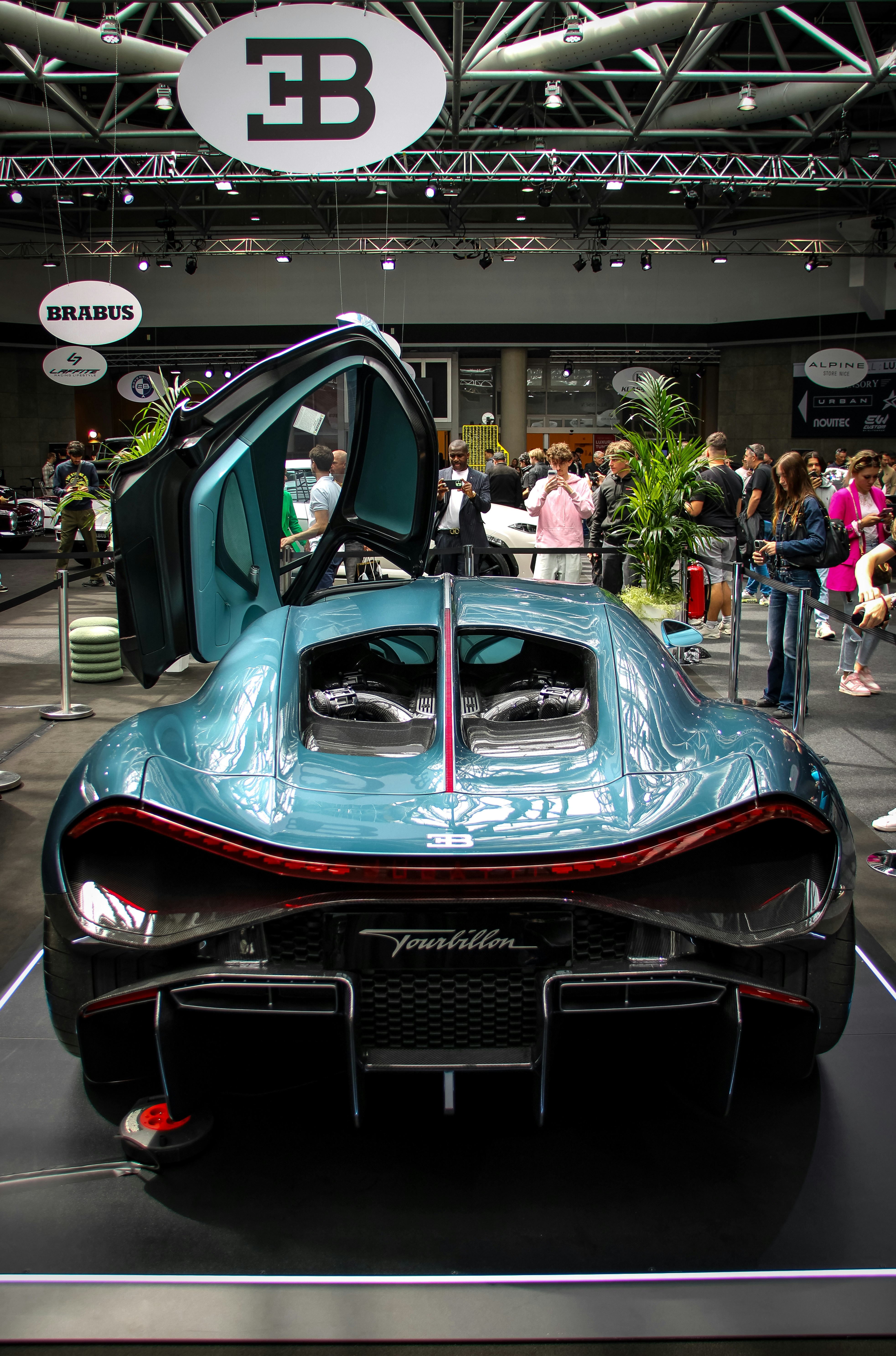 Teal Hypercar at Rear-View: A Showpiece Among Attendees