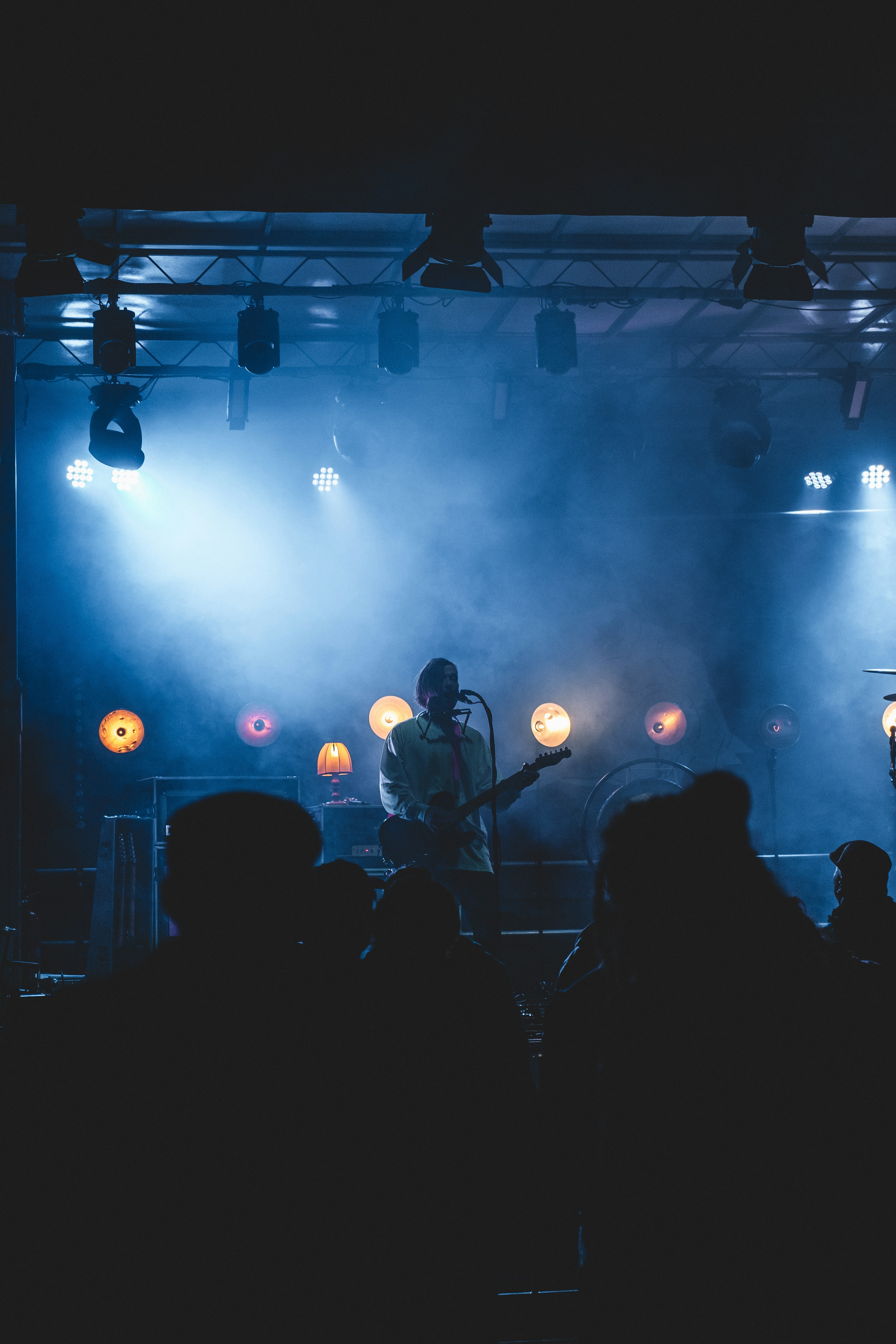 Blue Stage Shadows: A Guitarist Amid Neon Backlights