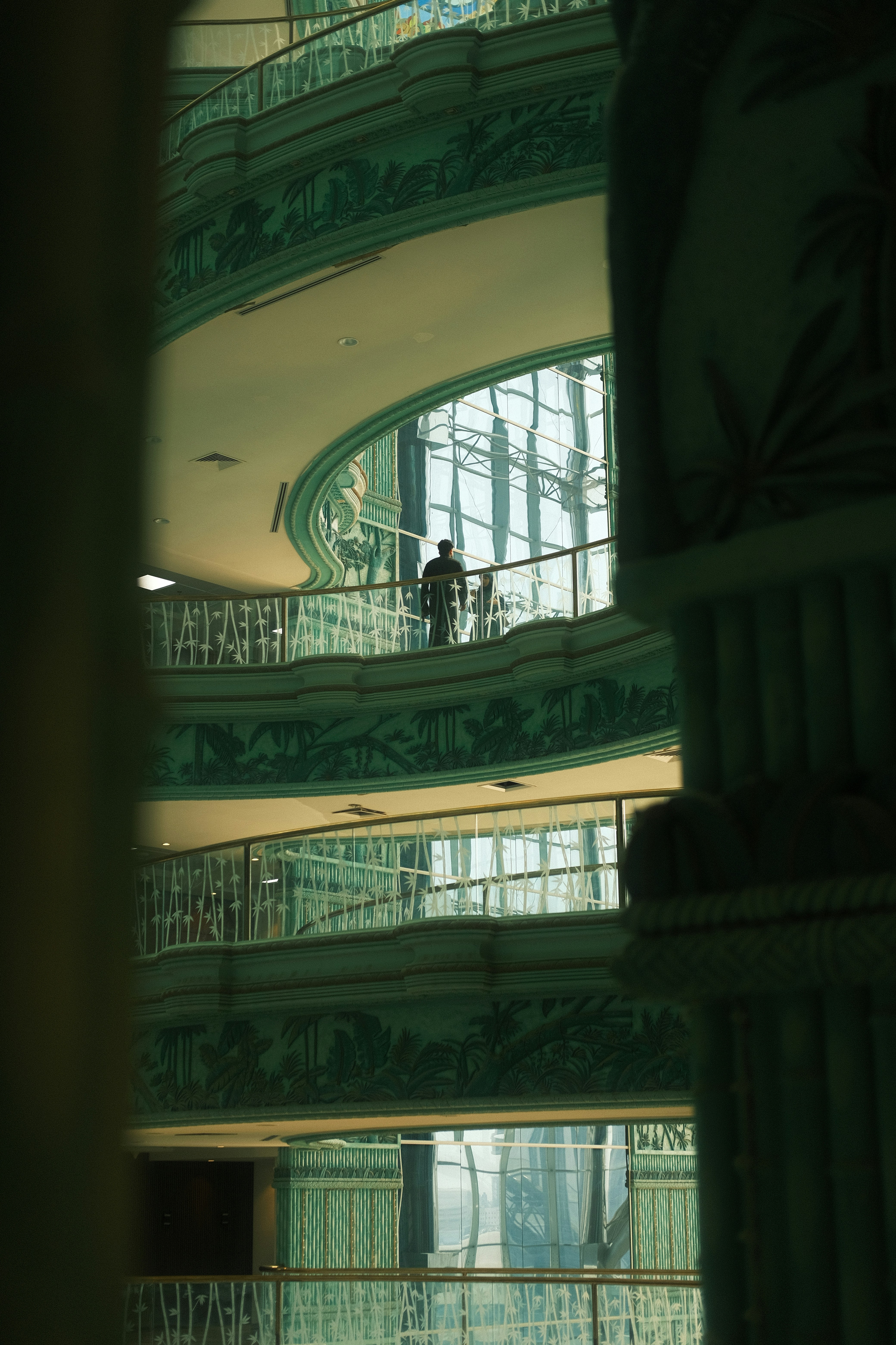 Silhouette on the Balcony: A Quiet Figure Amidst Architectural Echoes