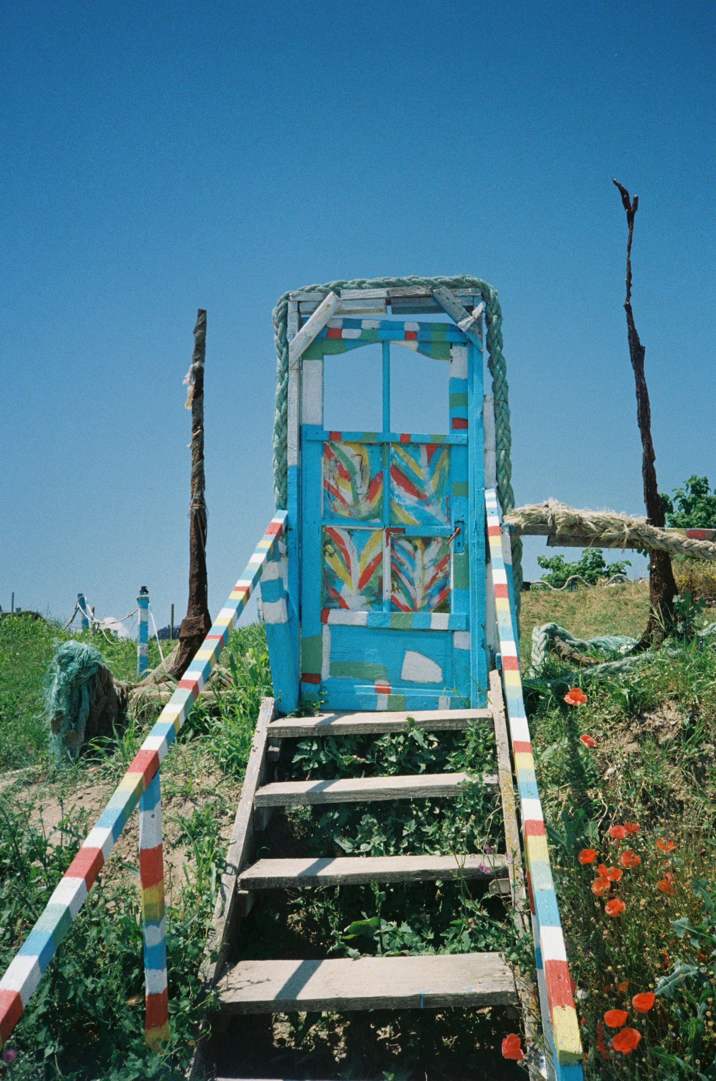 Colorful Staircase to a Painted Door in a Beachside Path