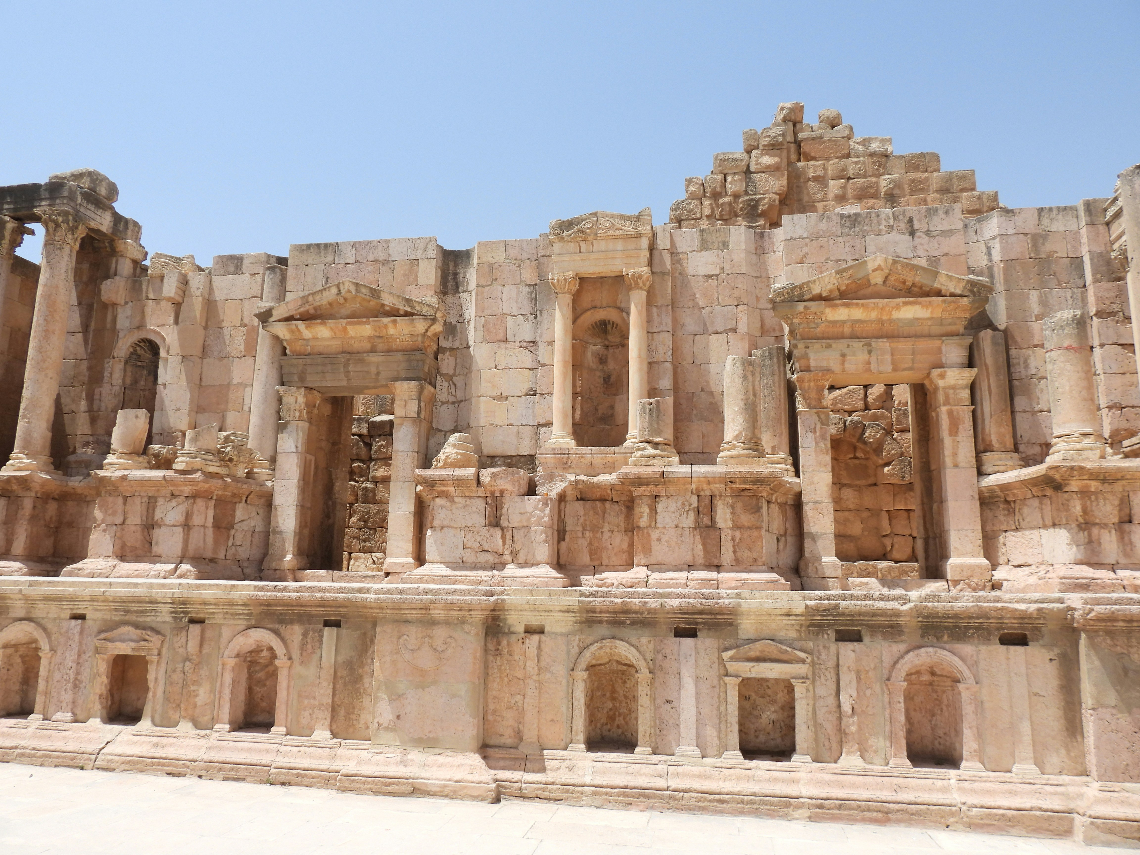 Sunlit Ruins: Ancient Facades Rise Beneath a Clear Sky