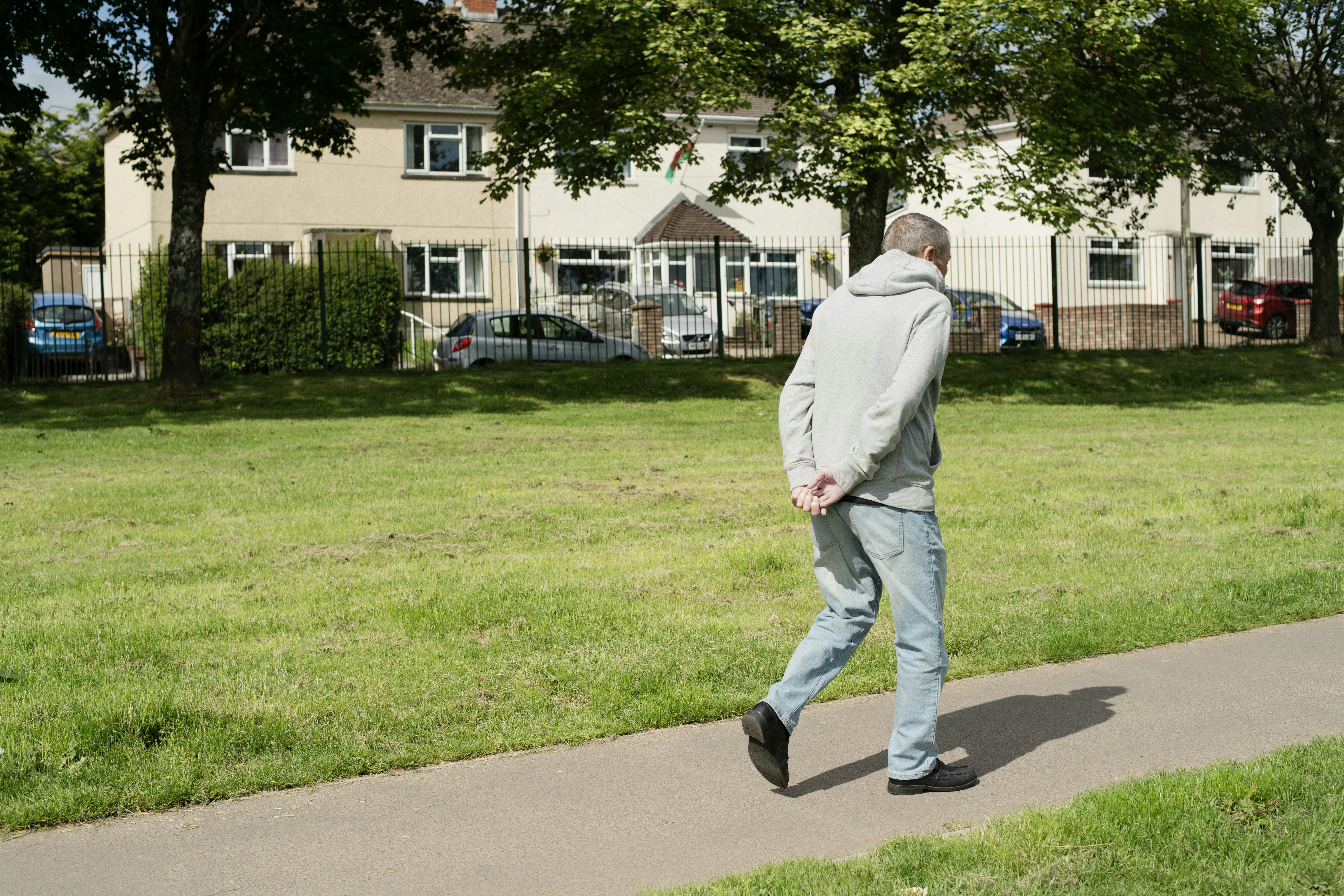 Lone Walker on a Quiet Park Path