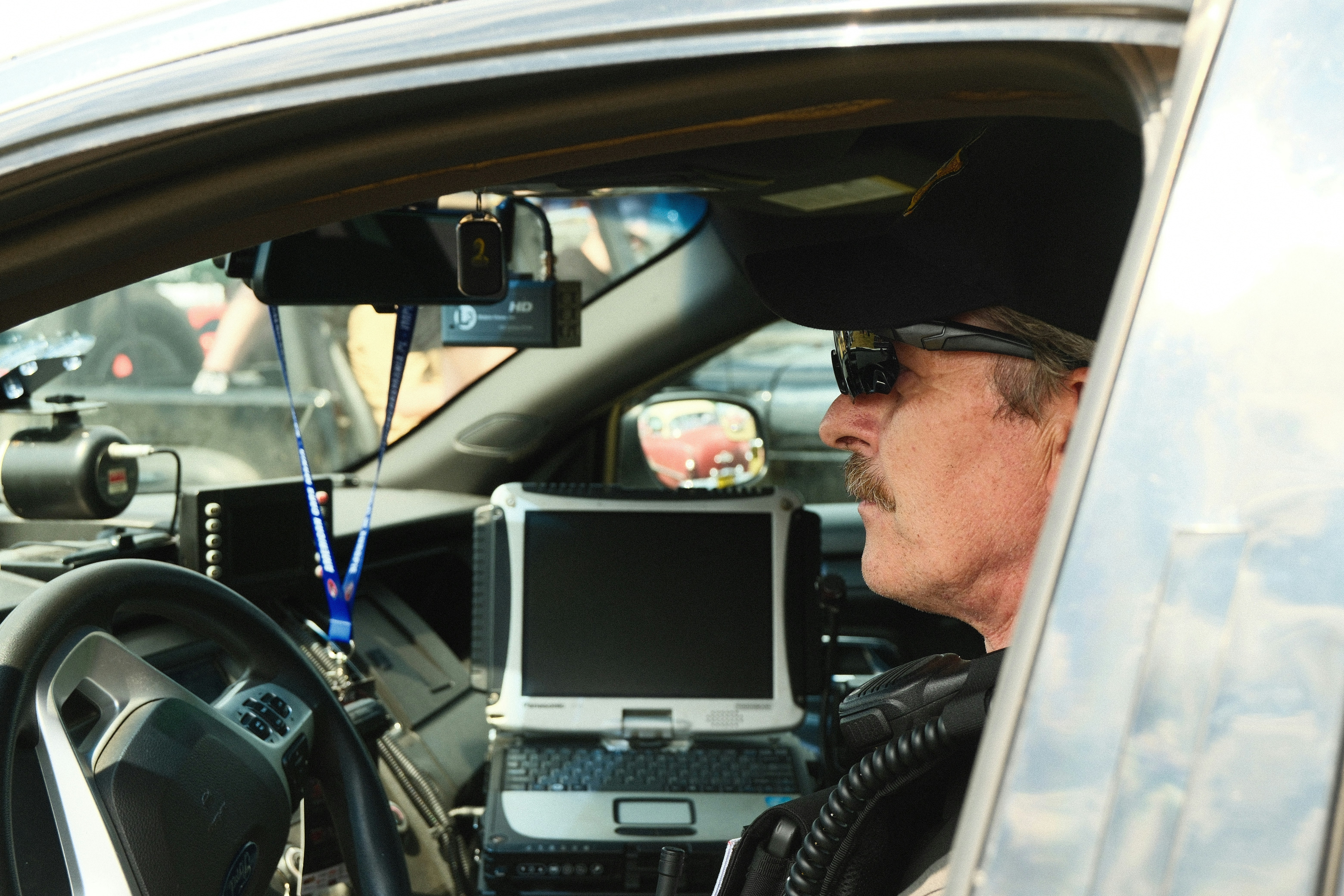 Officer in the Driver’s Seat: A Close-Glance Portrait Inside a Patrol Car