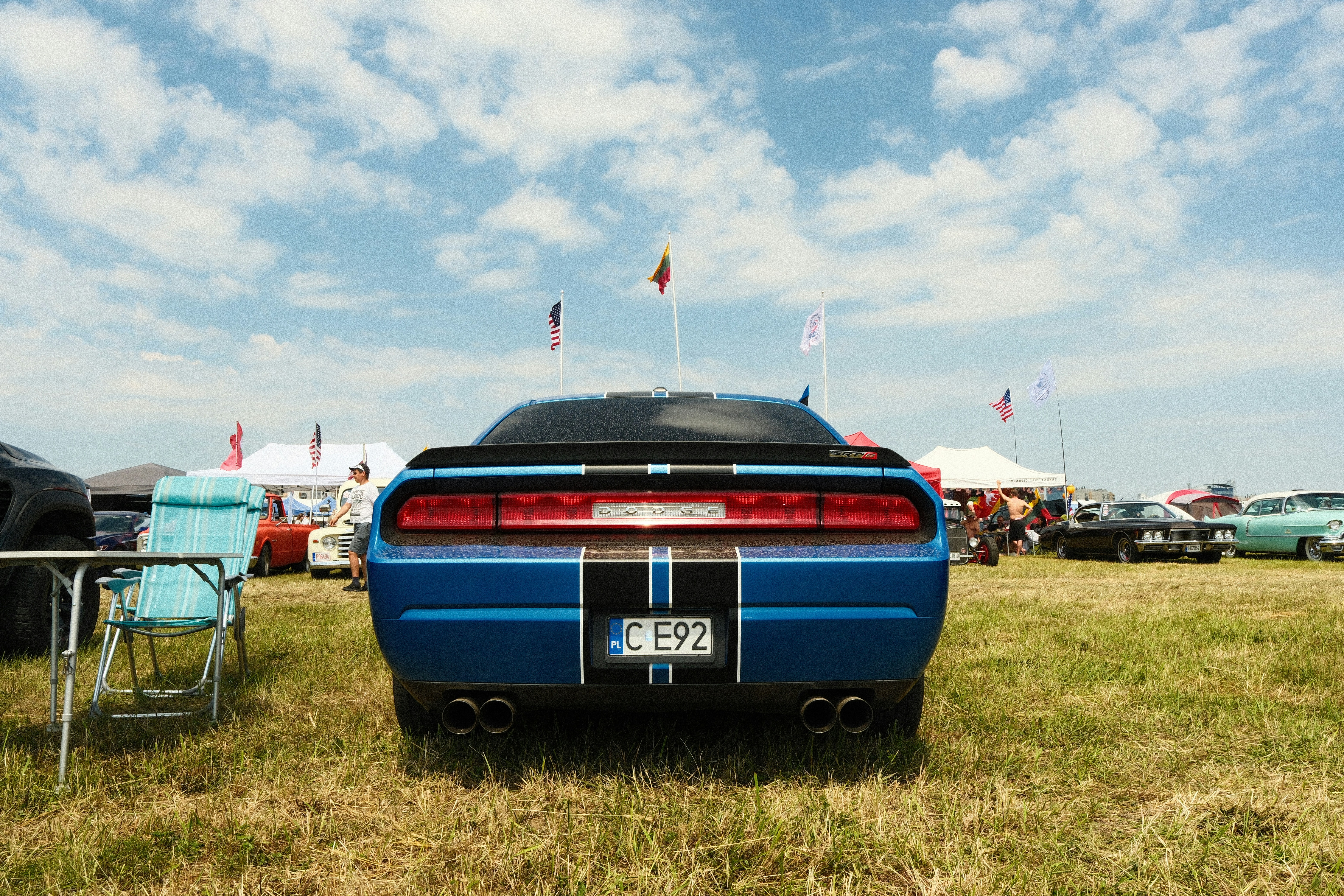 Rear View Blue Challenger at a Sunlit Car Show