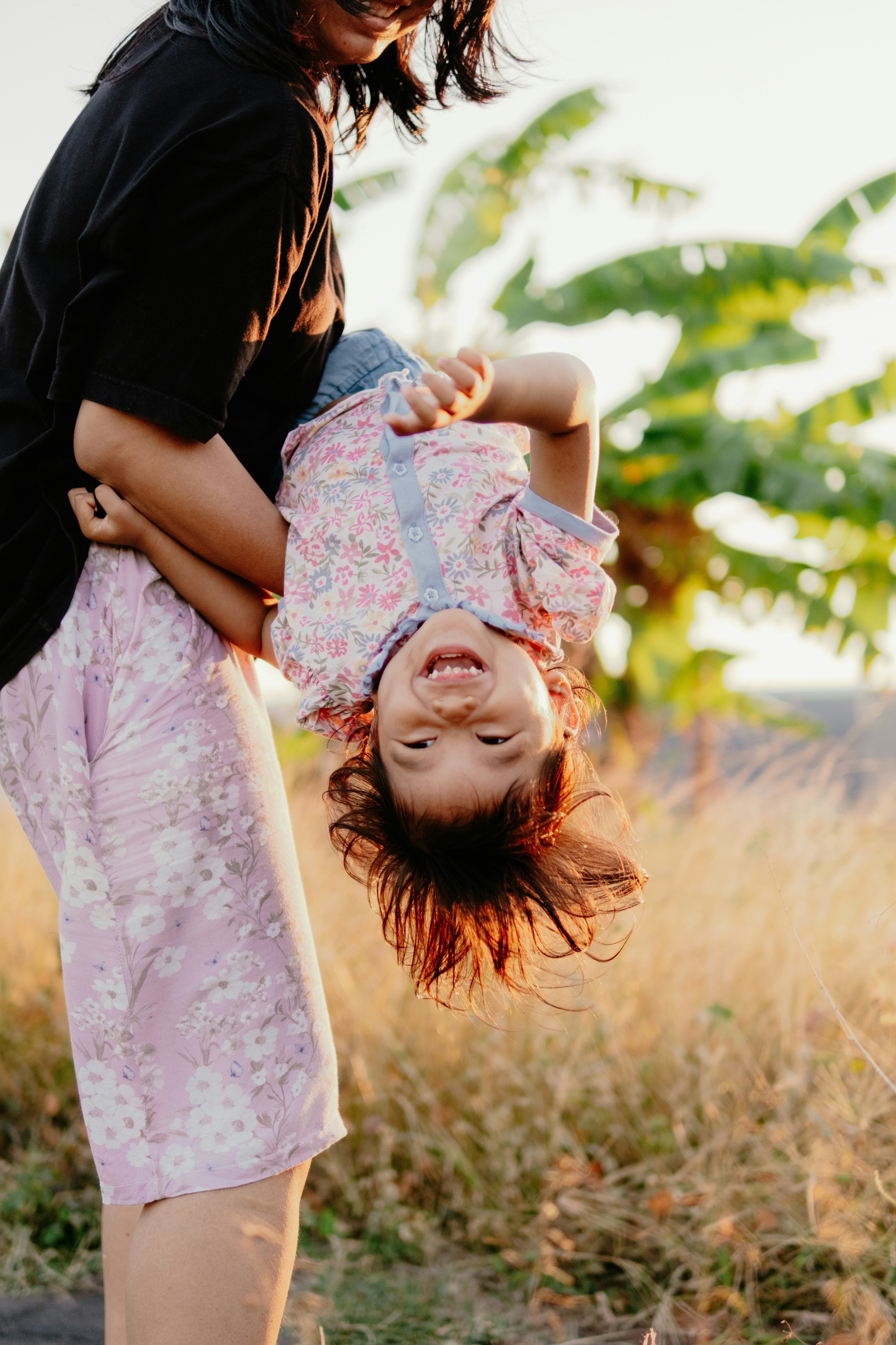 Upside-Down Joy: a giggling moment shared in late-afternoon light
