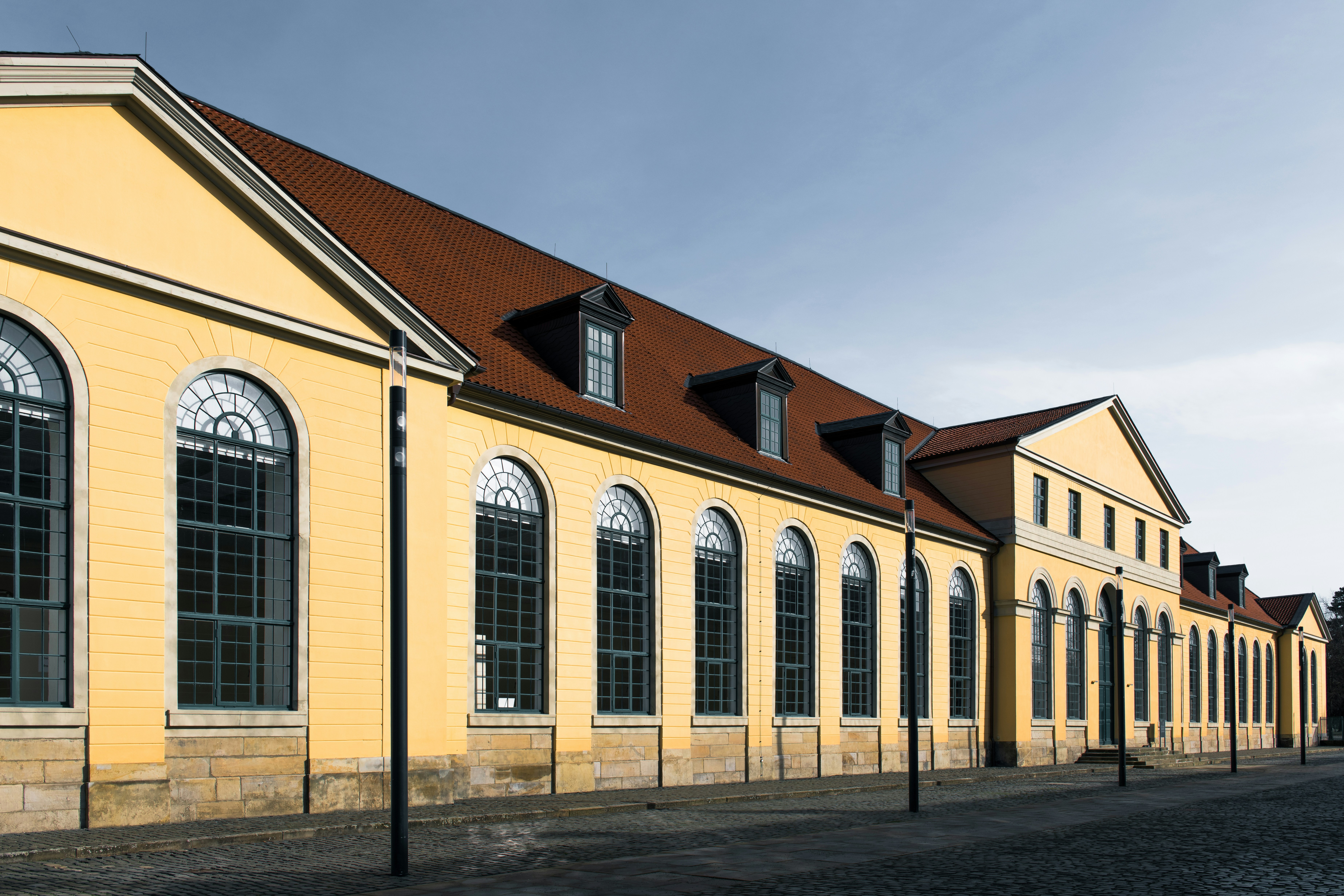 Sunlit Facade of a Long Yellow Arcade