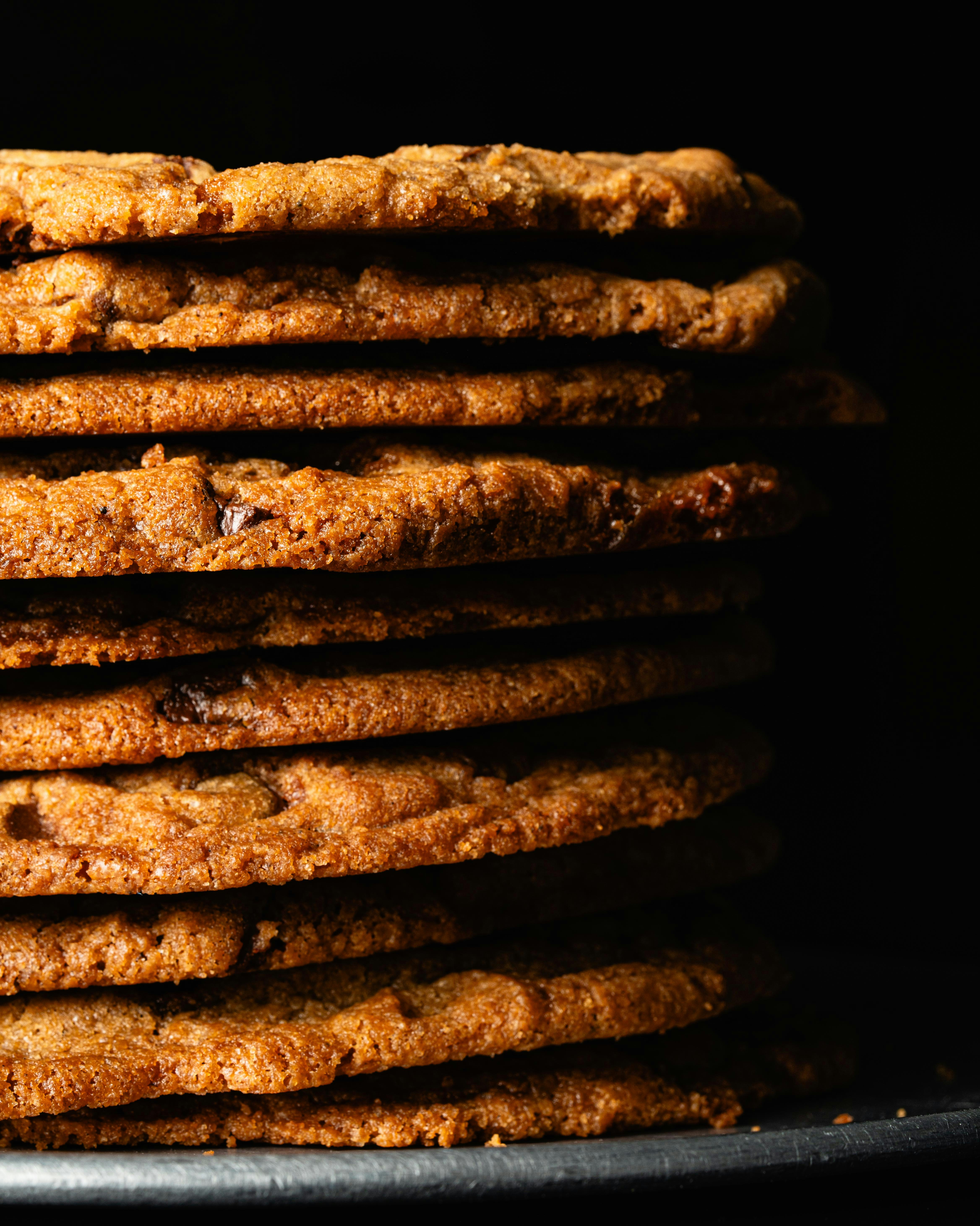 Amber Layers: A Close Stack of Crunchy Cookies in Warm Light