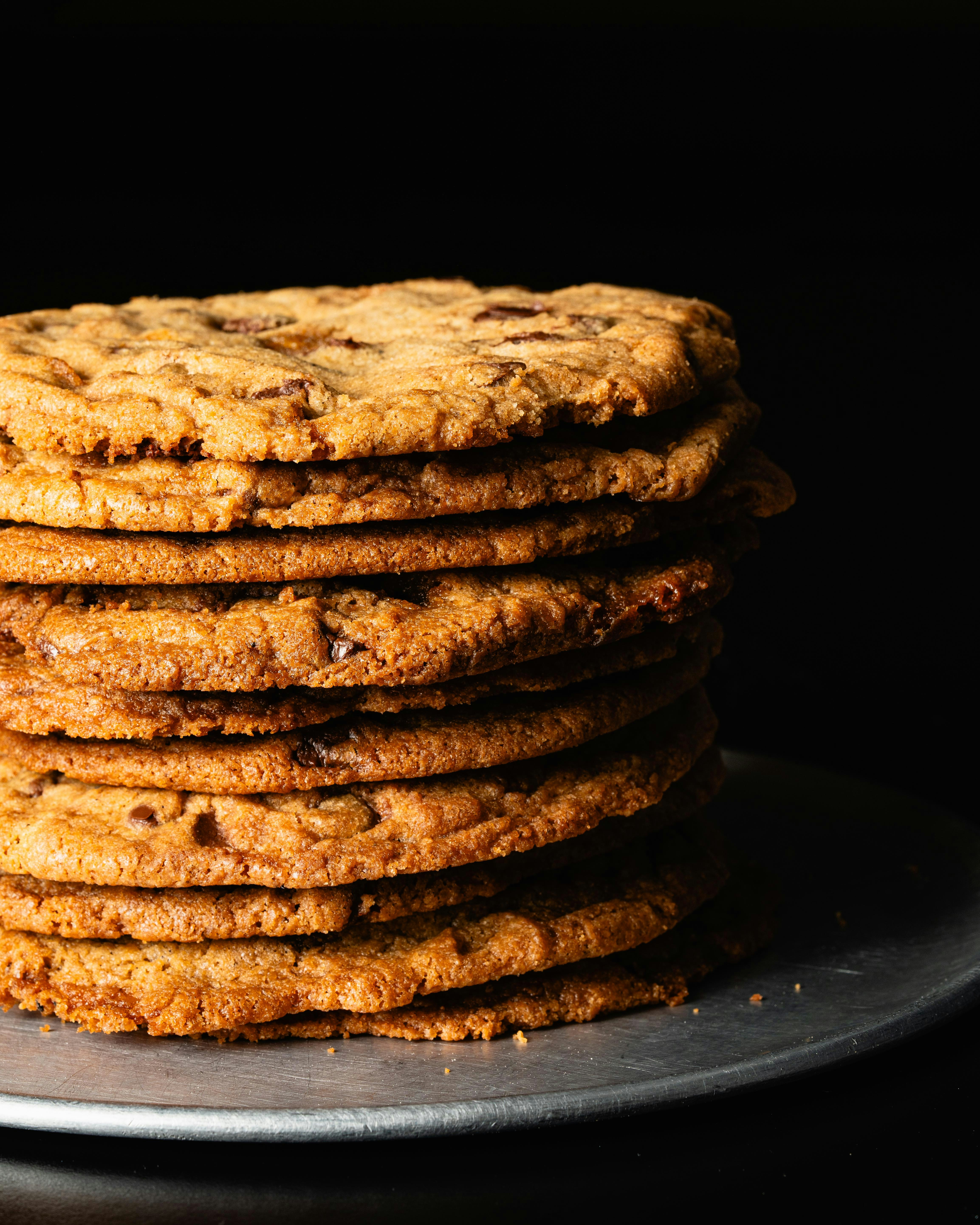Cradled Stack: Rustic Cookie Tower Against a Velvet Black