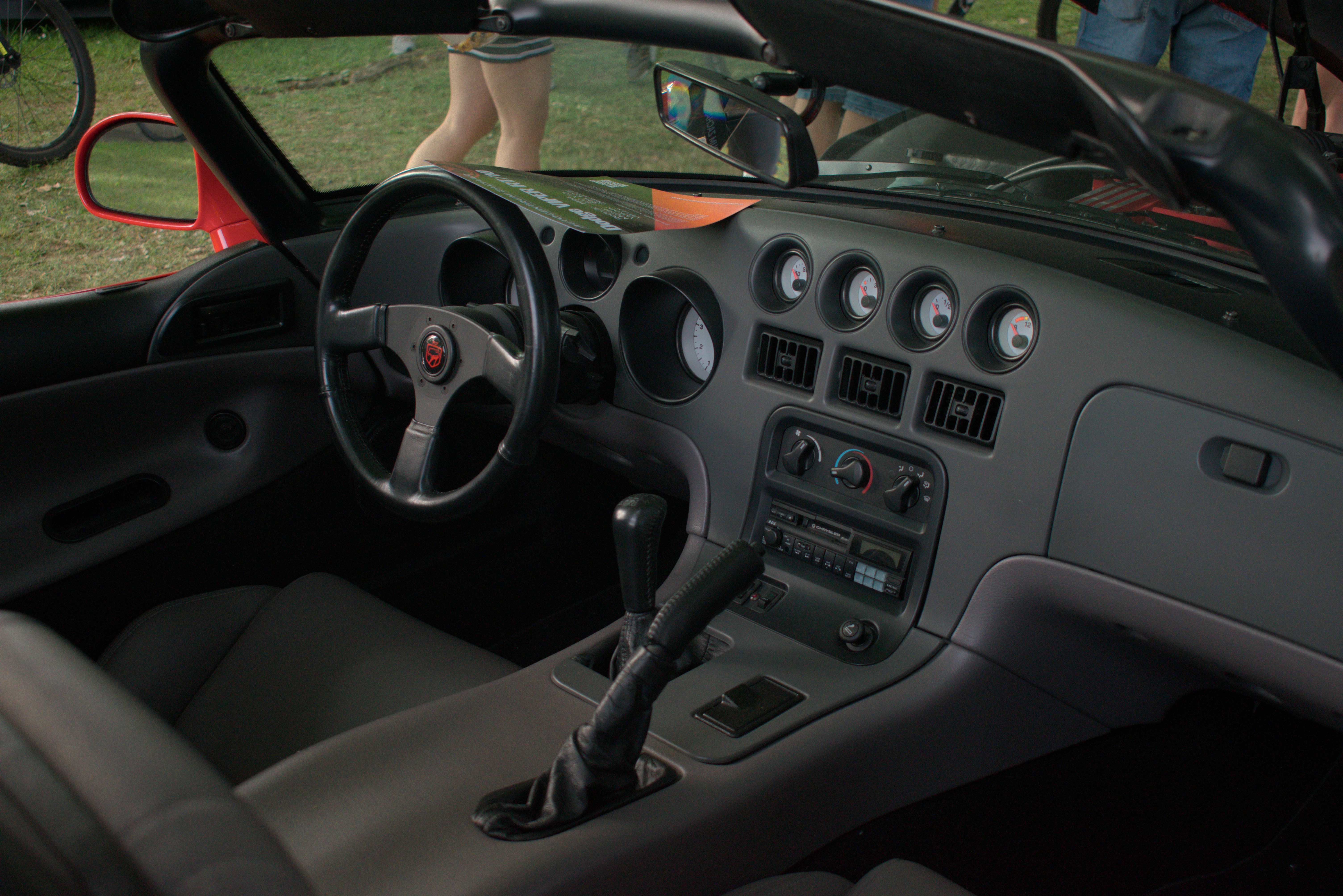 Stitched cockpit: a classic mid-90s sports car interior under soft daylight
