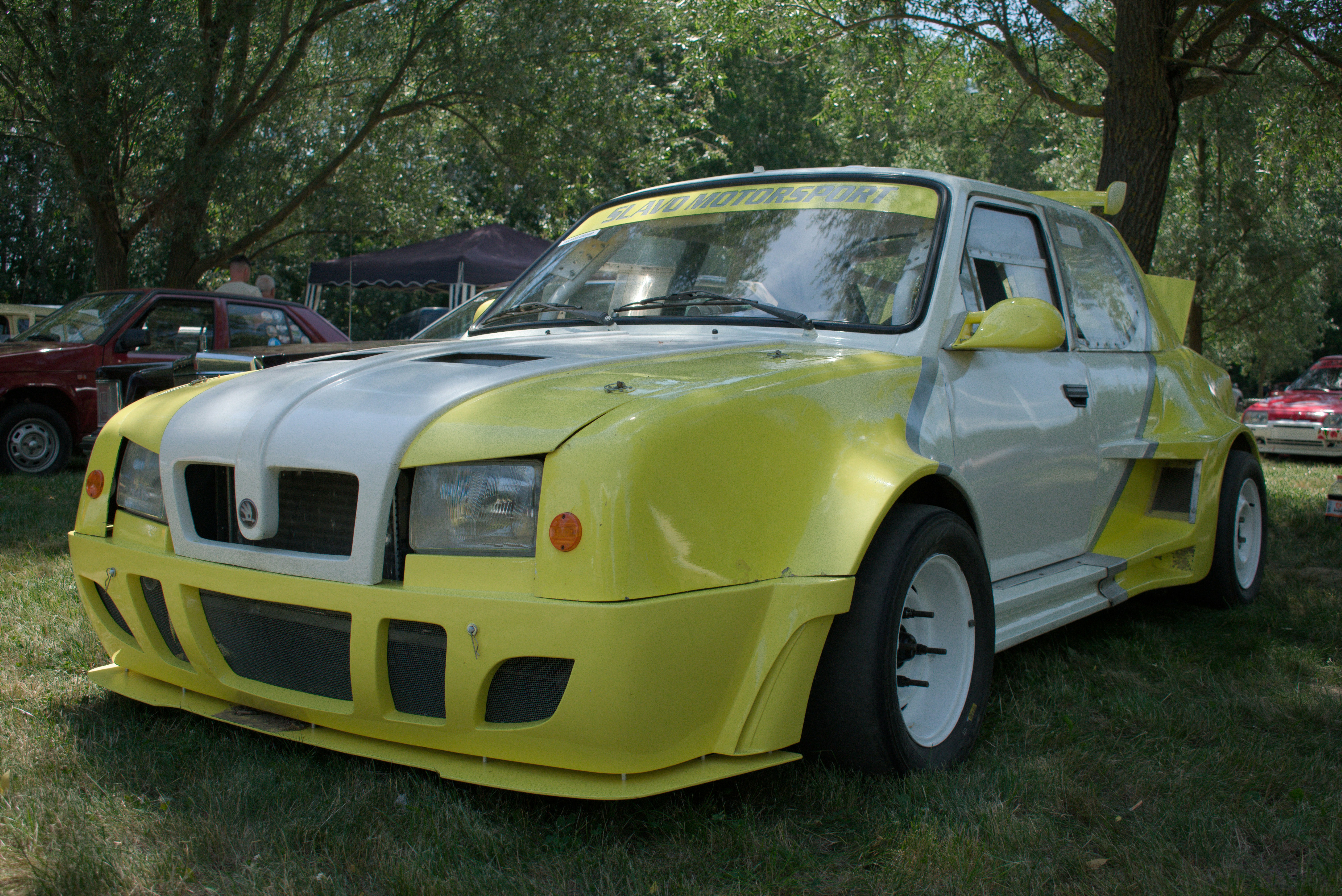 Yellow-Rimmed Showcar Stance on a Sunlit Lawn