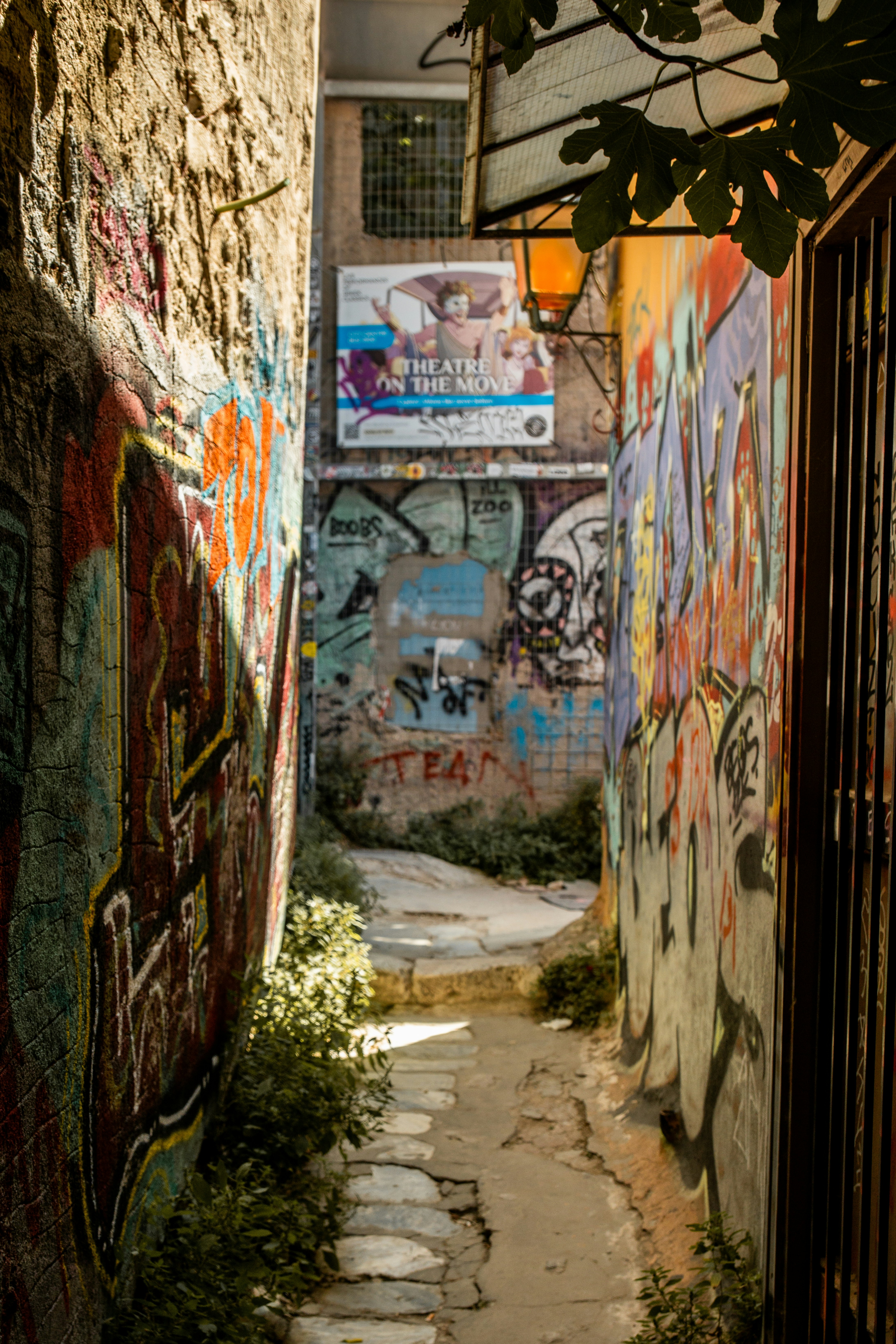 Graffiti Alley Leading to a Sunlit Poster Corridor