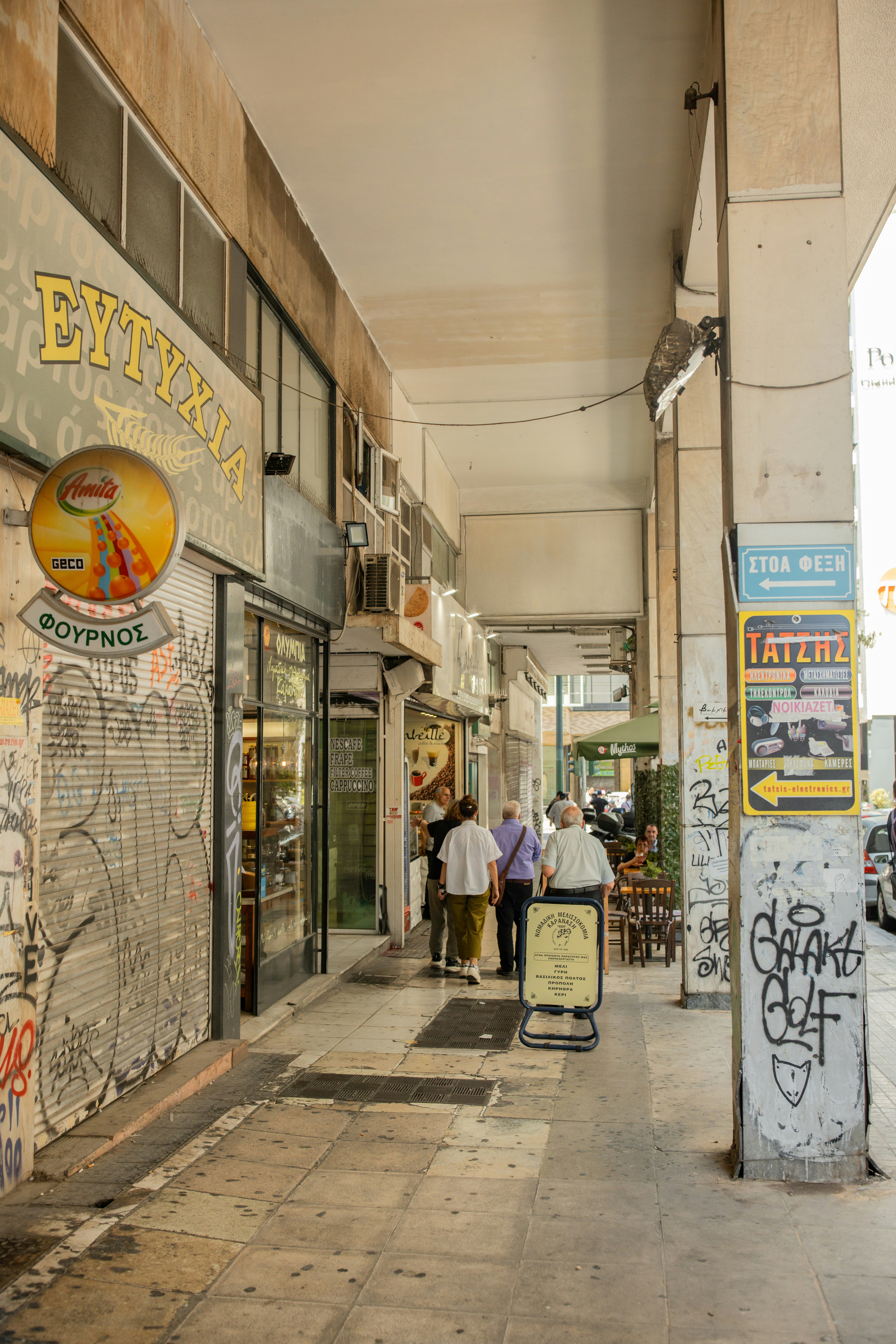 Urban Arcade: Shaded Alleyway Faces a Quiet Congregation