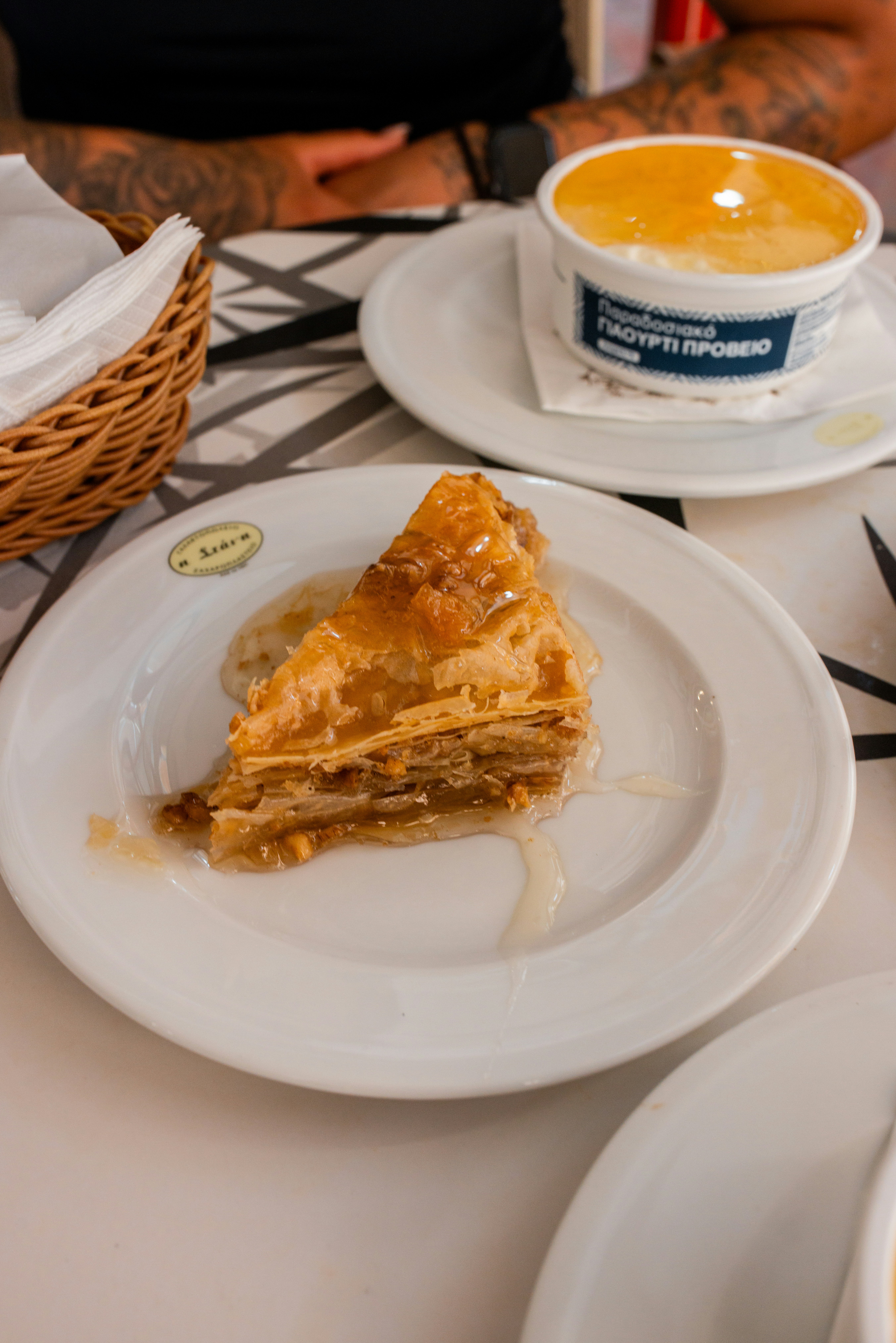 Slice of Donut-Top Pastry with Syrup and a Creamy Dessert Cup in a Cozy Café