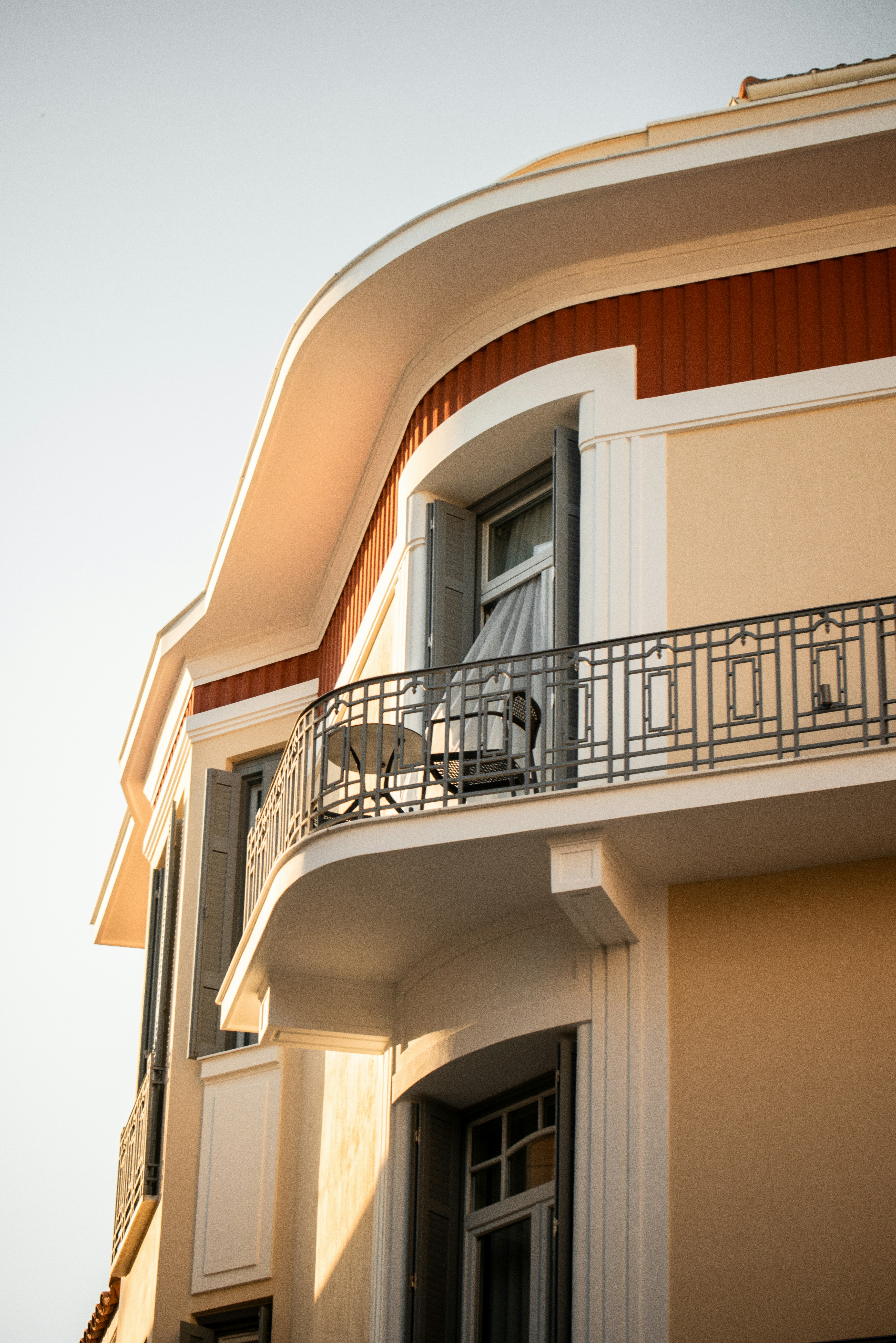 Sunlit Corner Balcony of a Curved-Edge Empire