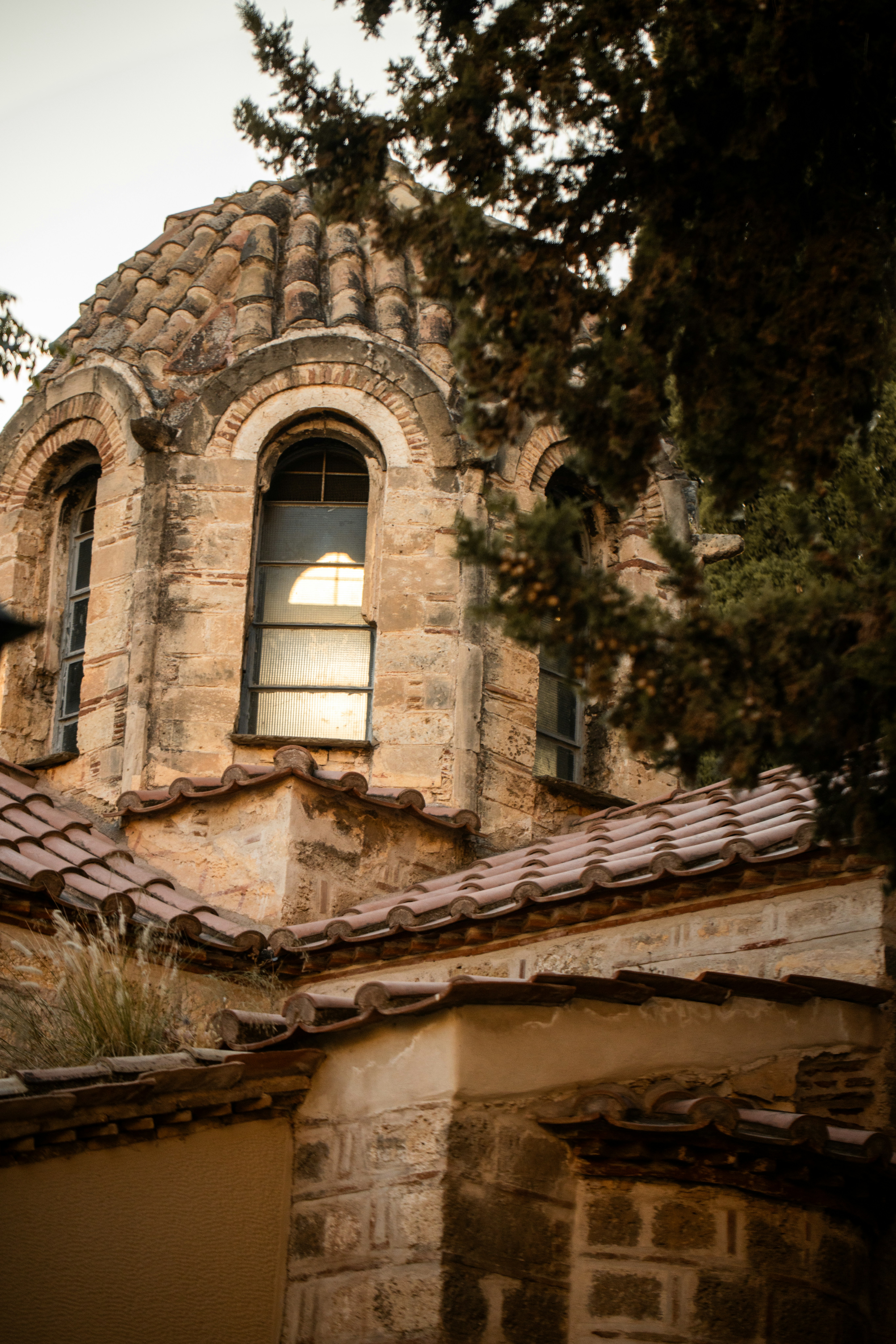 Stone Dome and Tiled Rooftops: Vintage Architecture Framed by Cedar