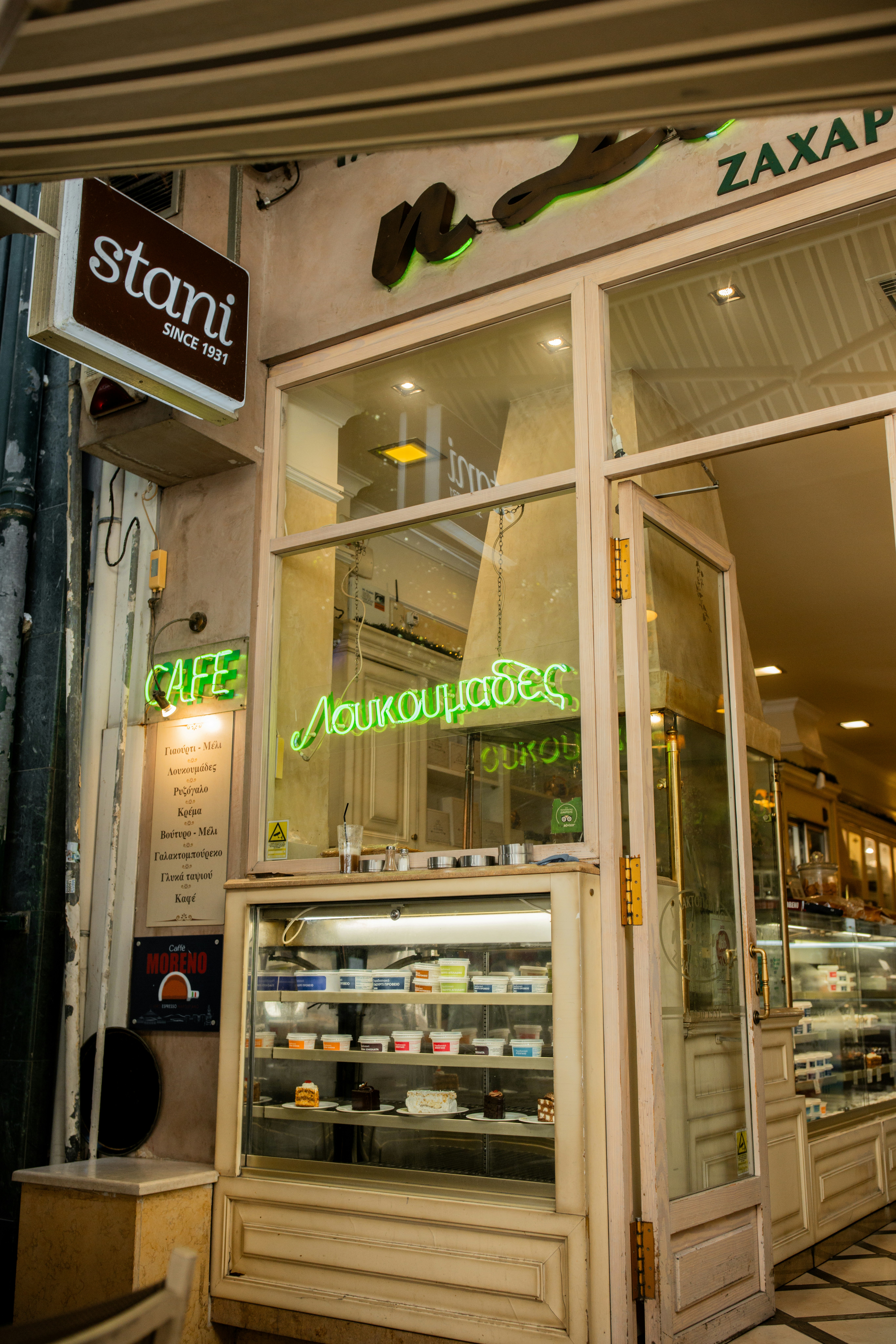 Neon Green Café Sign Reflections in a Georgian Bakery Display