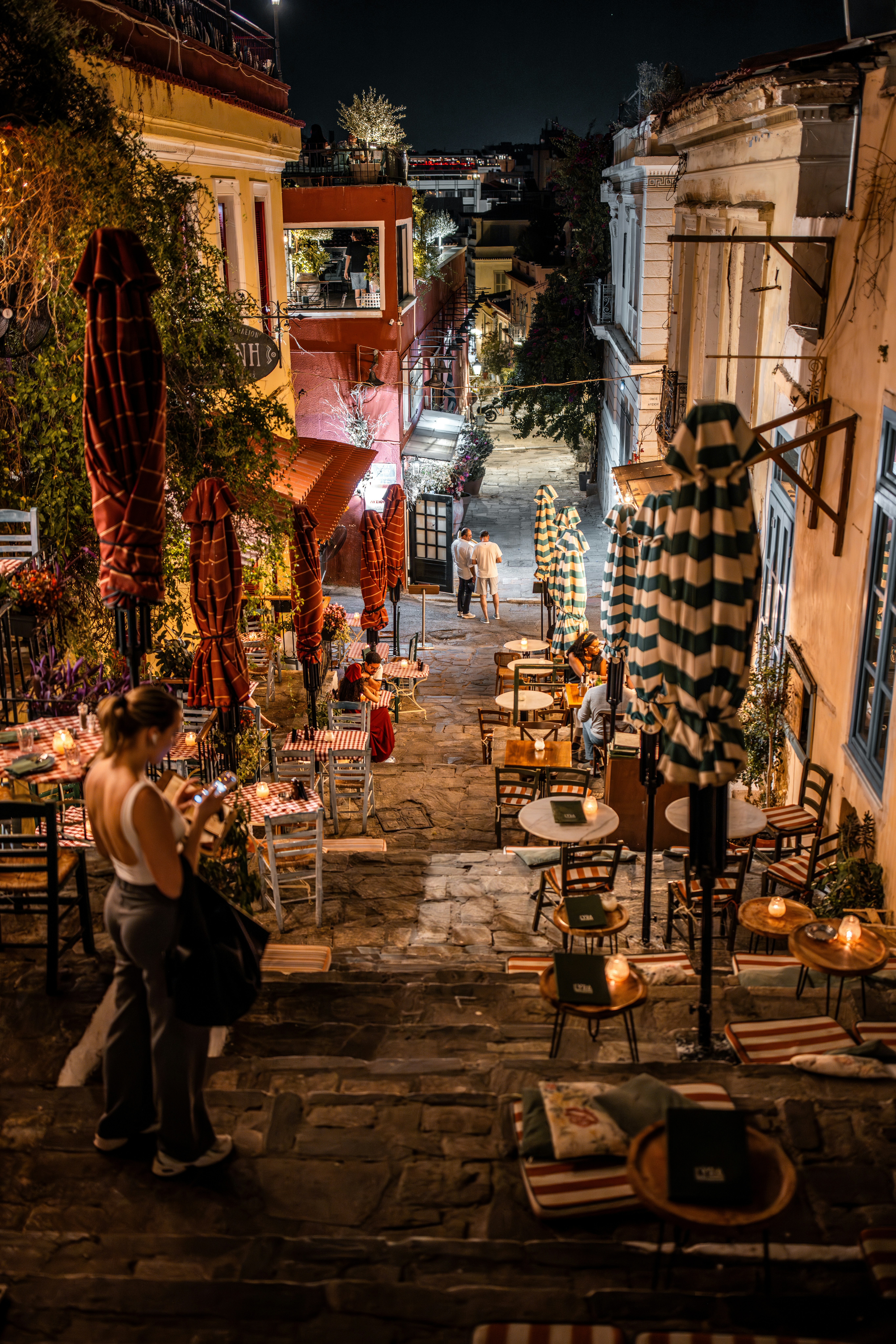Nightfall in the Stone Alley: Bistro Lights and Quiet Figures