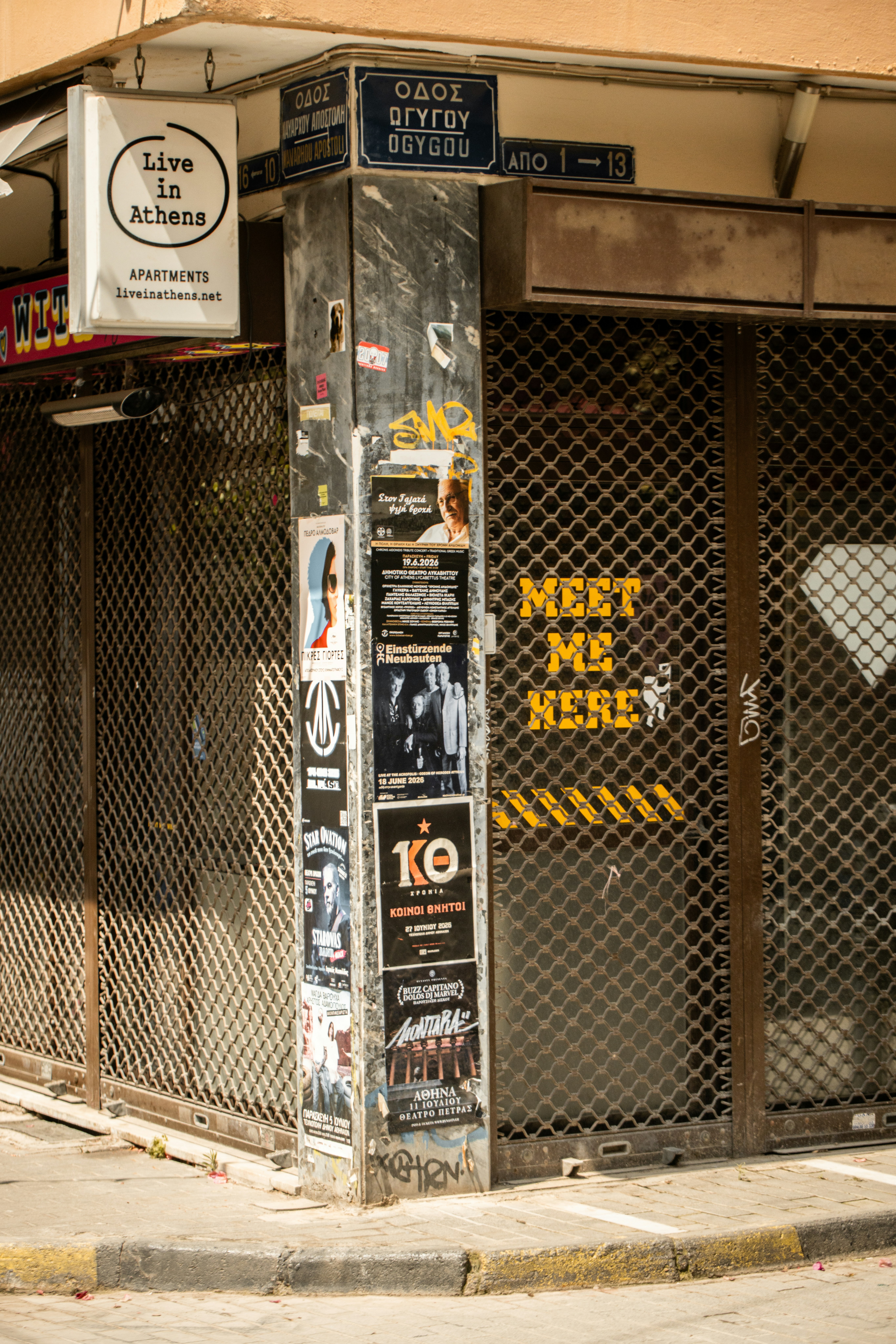 Locked Shopfront: Posters, Graffiti, and a Heart-Shaped Cutout