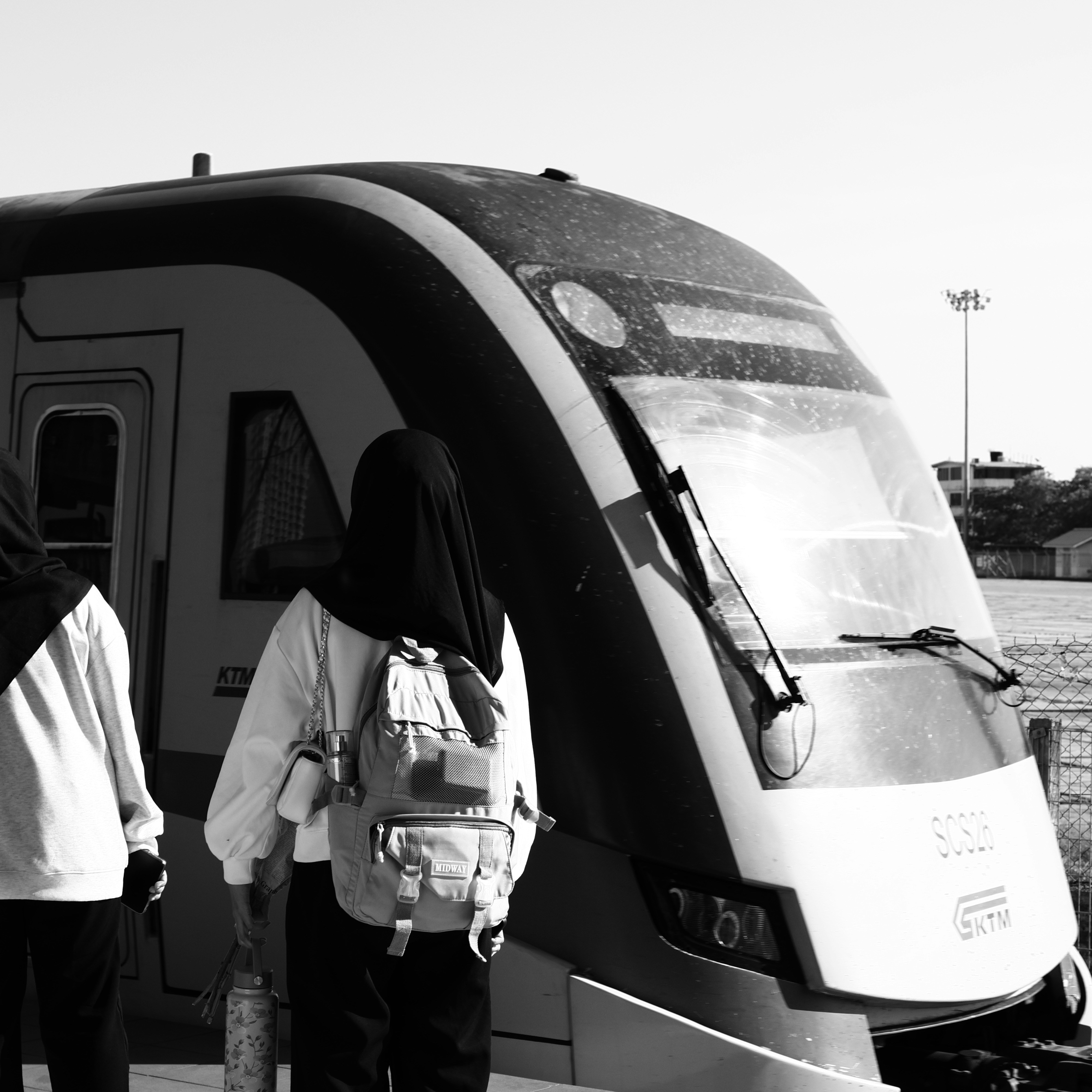 Traveler at a Modern Railcar: Quiet Momentum by the Platform