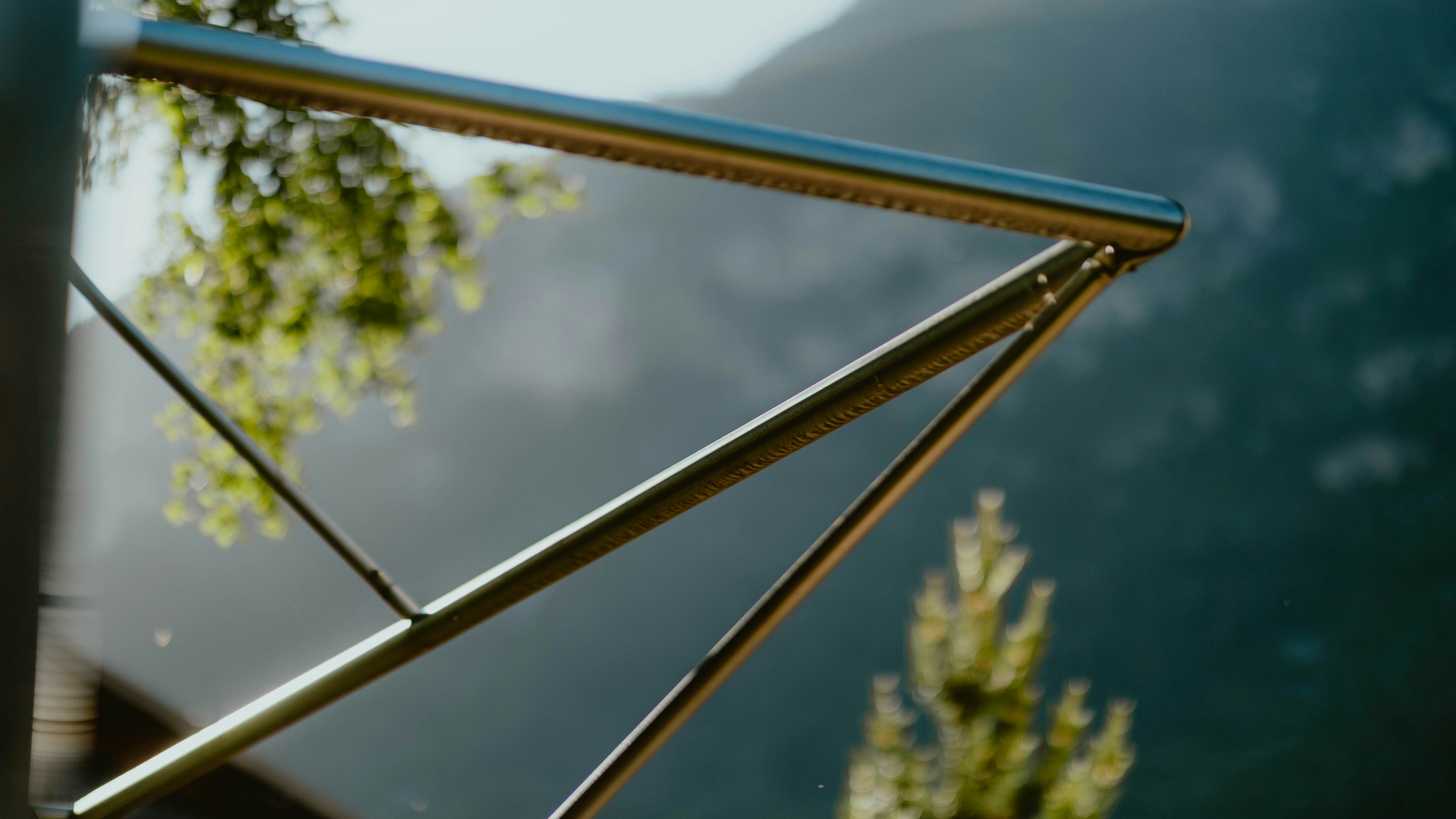 Angular canopy: steel braces framing a sunlit alpine vista