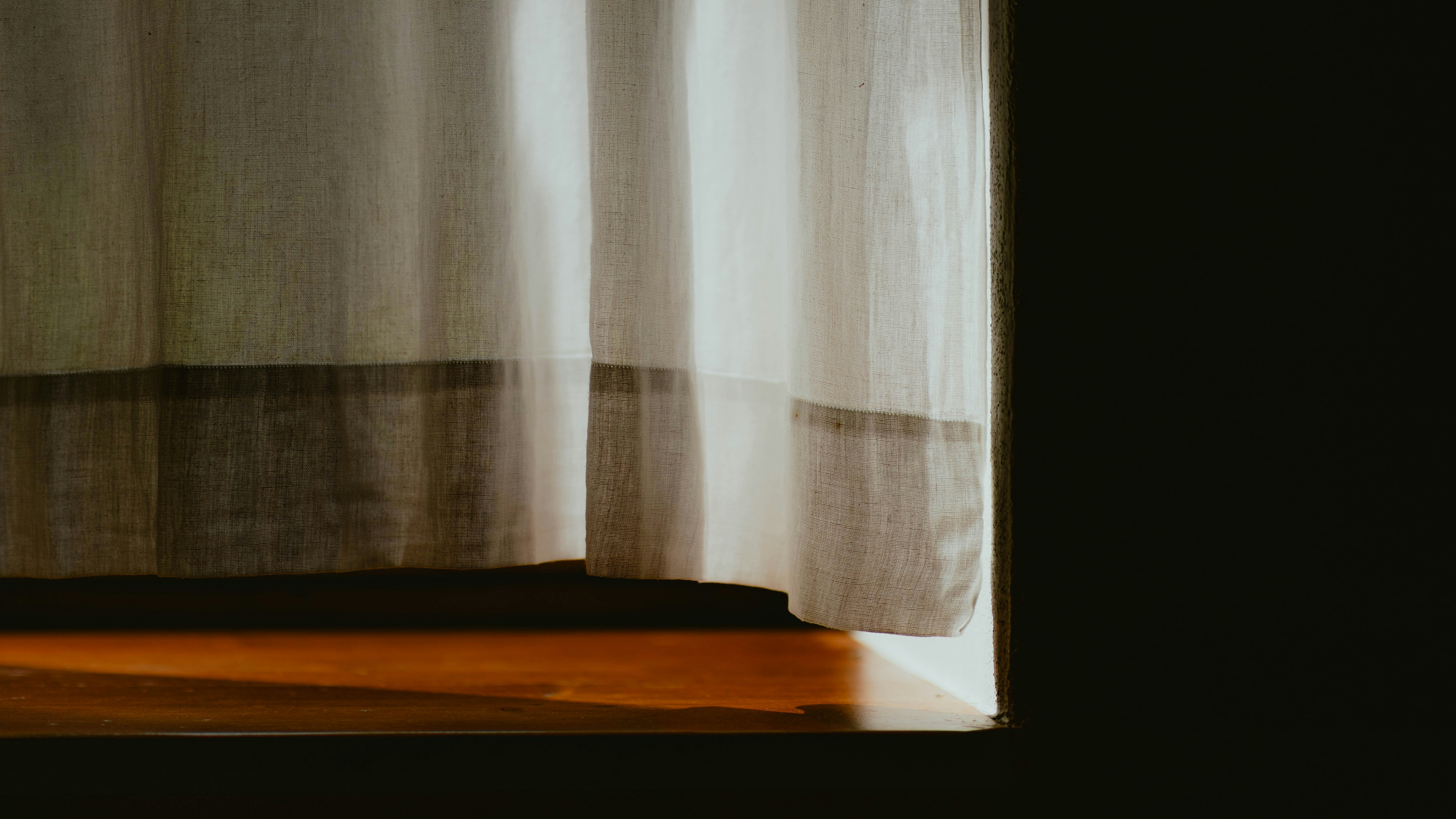 Curtain Gap: Subtle Light Framing a Stage of Shadow