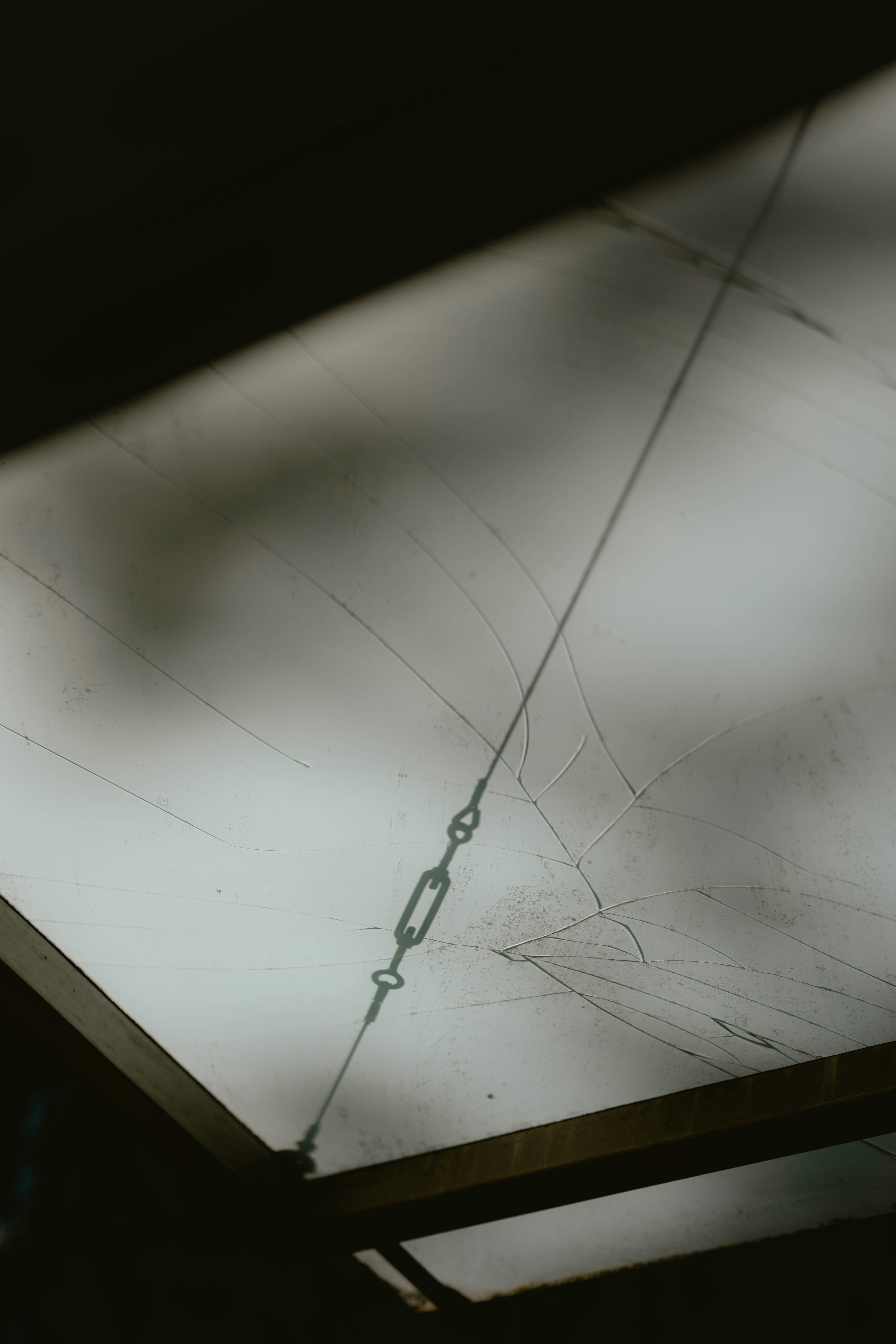 Fractured Glass and Hanging Chain: An Abandoned Skylight Portrait