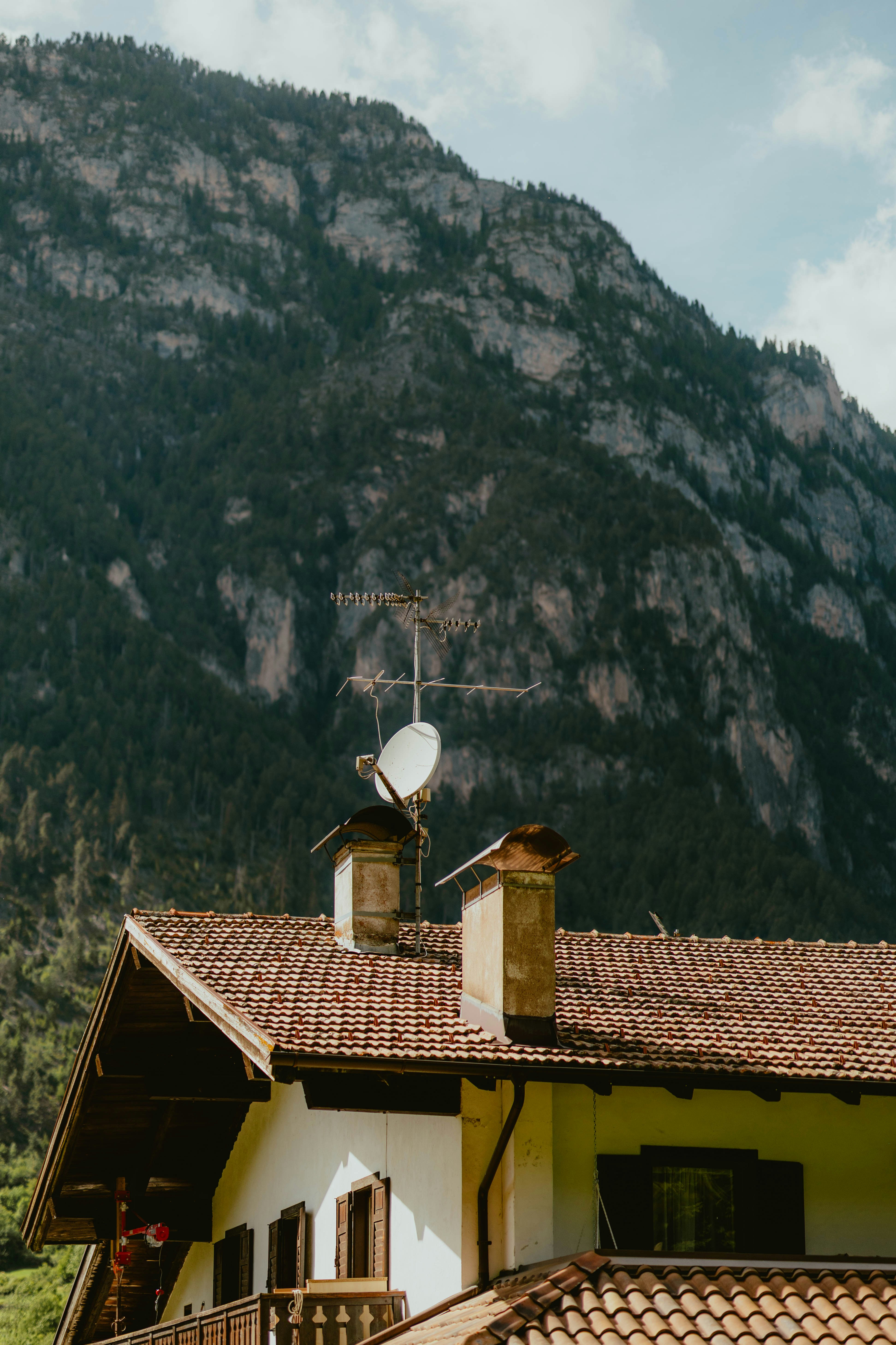 Ridge-roofed Chalet Under a towering Alpine Peak