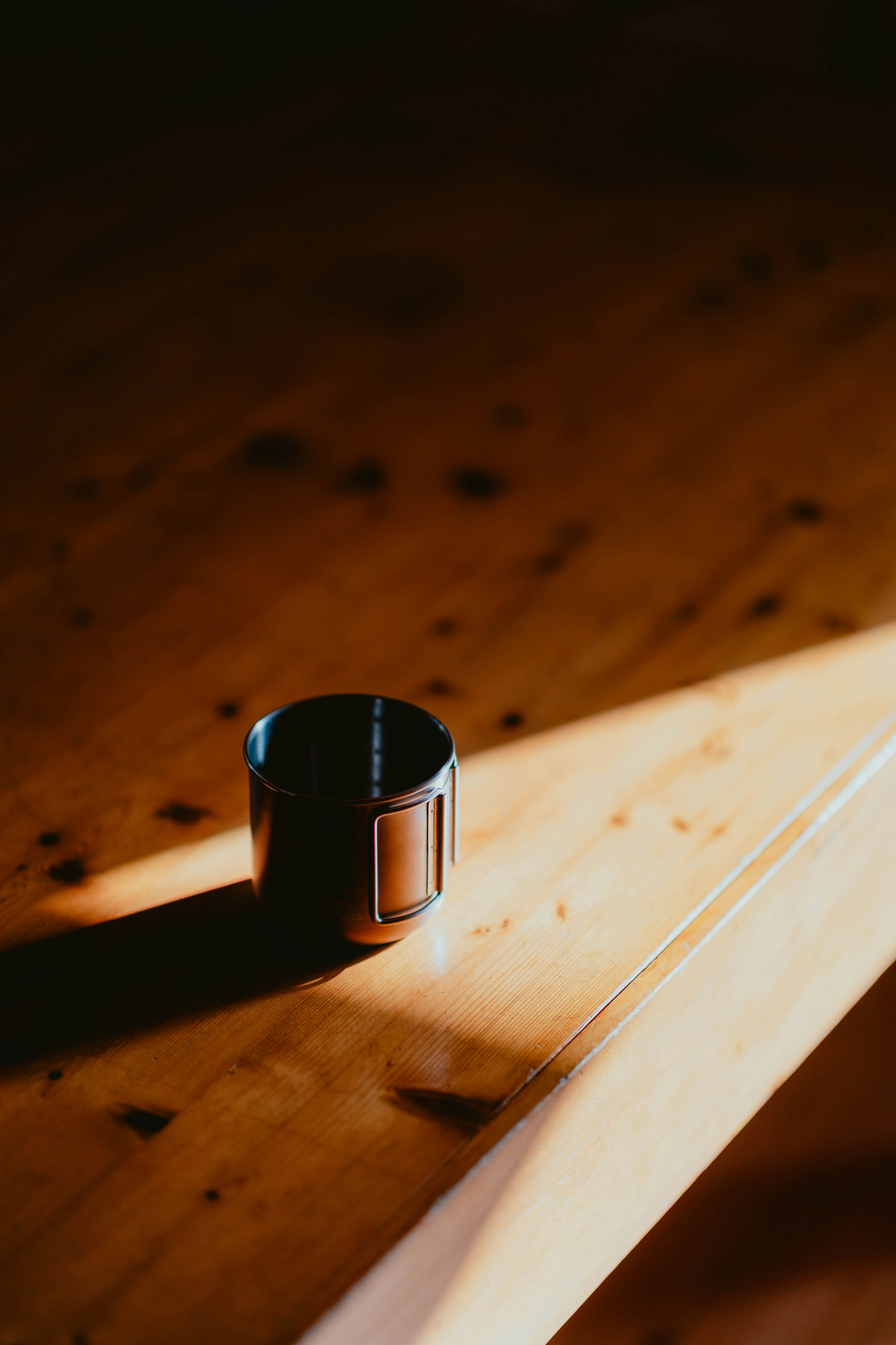 Ring of Focus: A Single Metal Ring on a Sunny Wooden Table