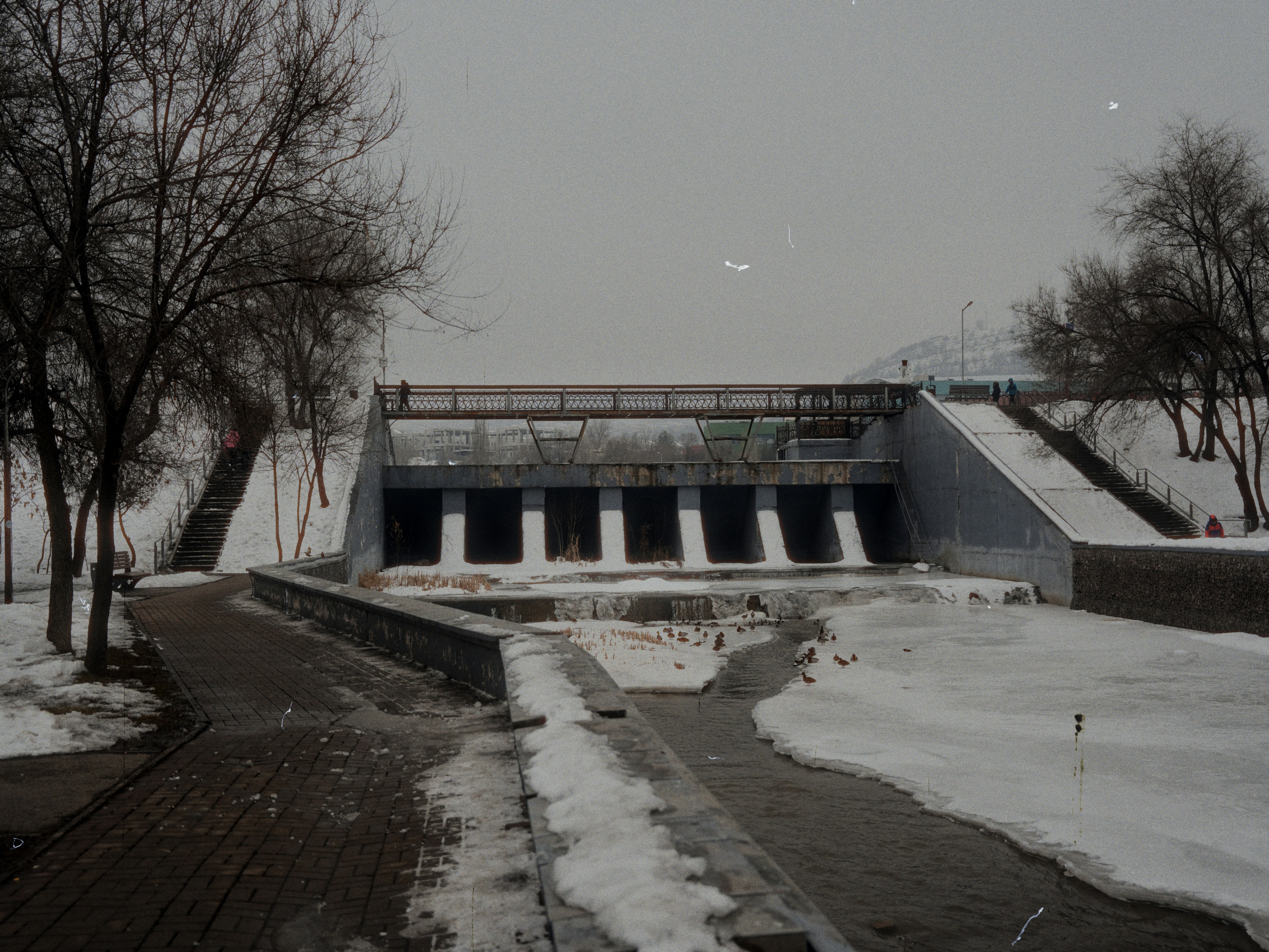 Snowlit Dam Gate Symmetry Under a Quiet Winter Sky