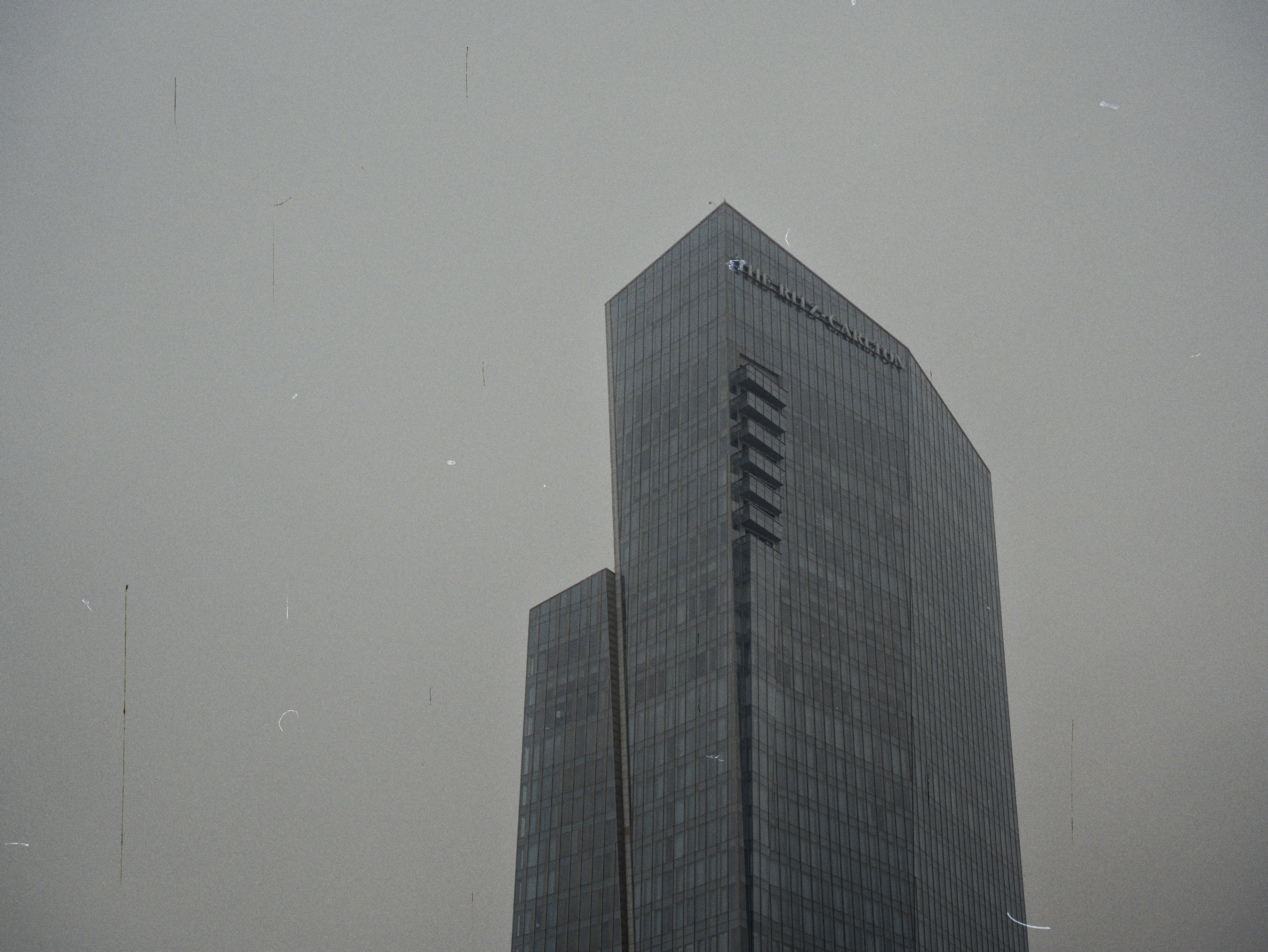 Monolithic Skyline: Twin Towers Cut by Overcast Light